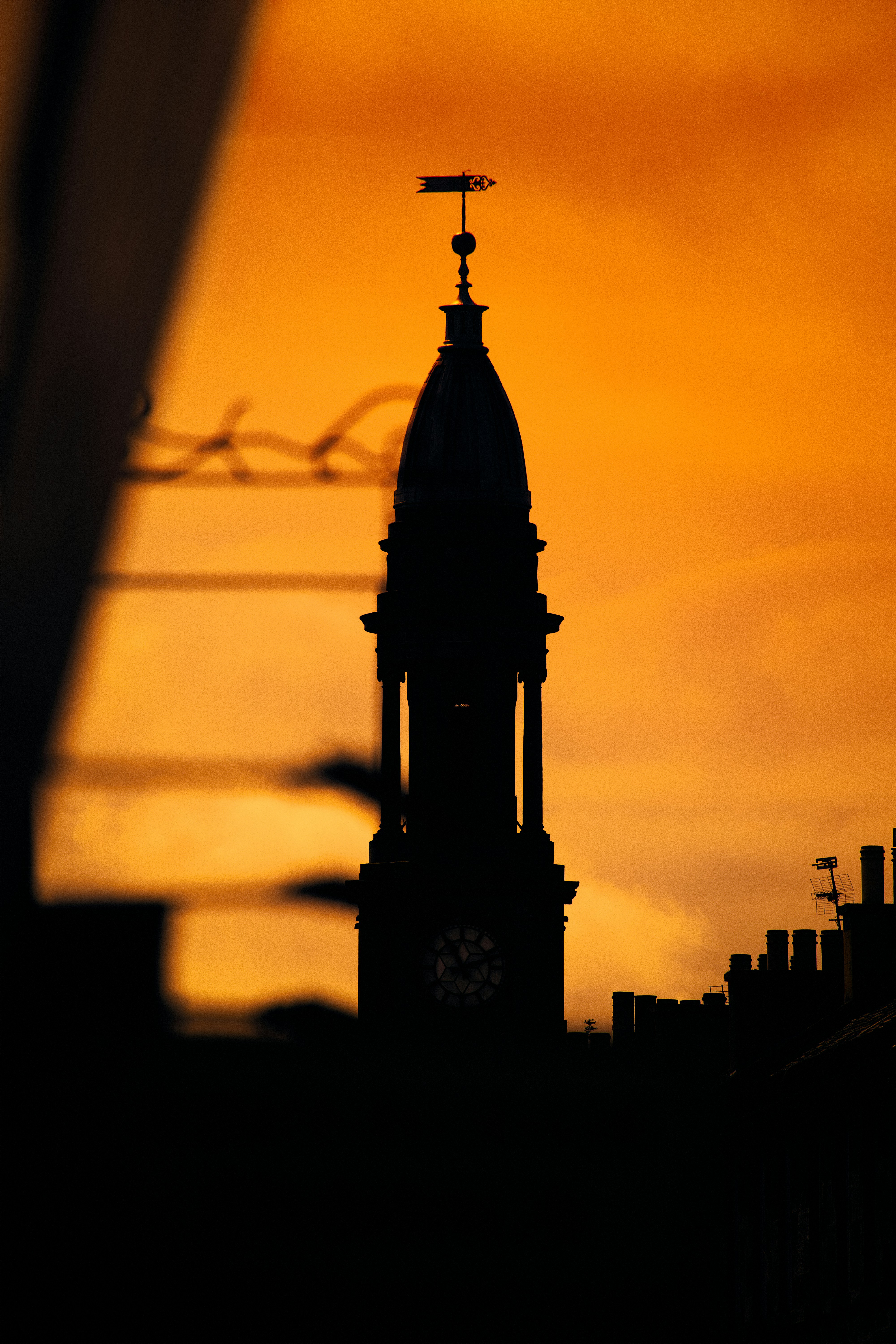 Silhouette Clock Tower Against A Fiery Sunset