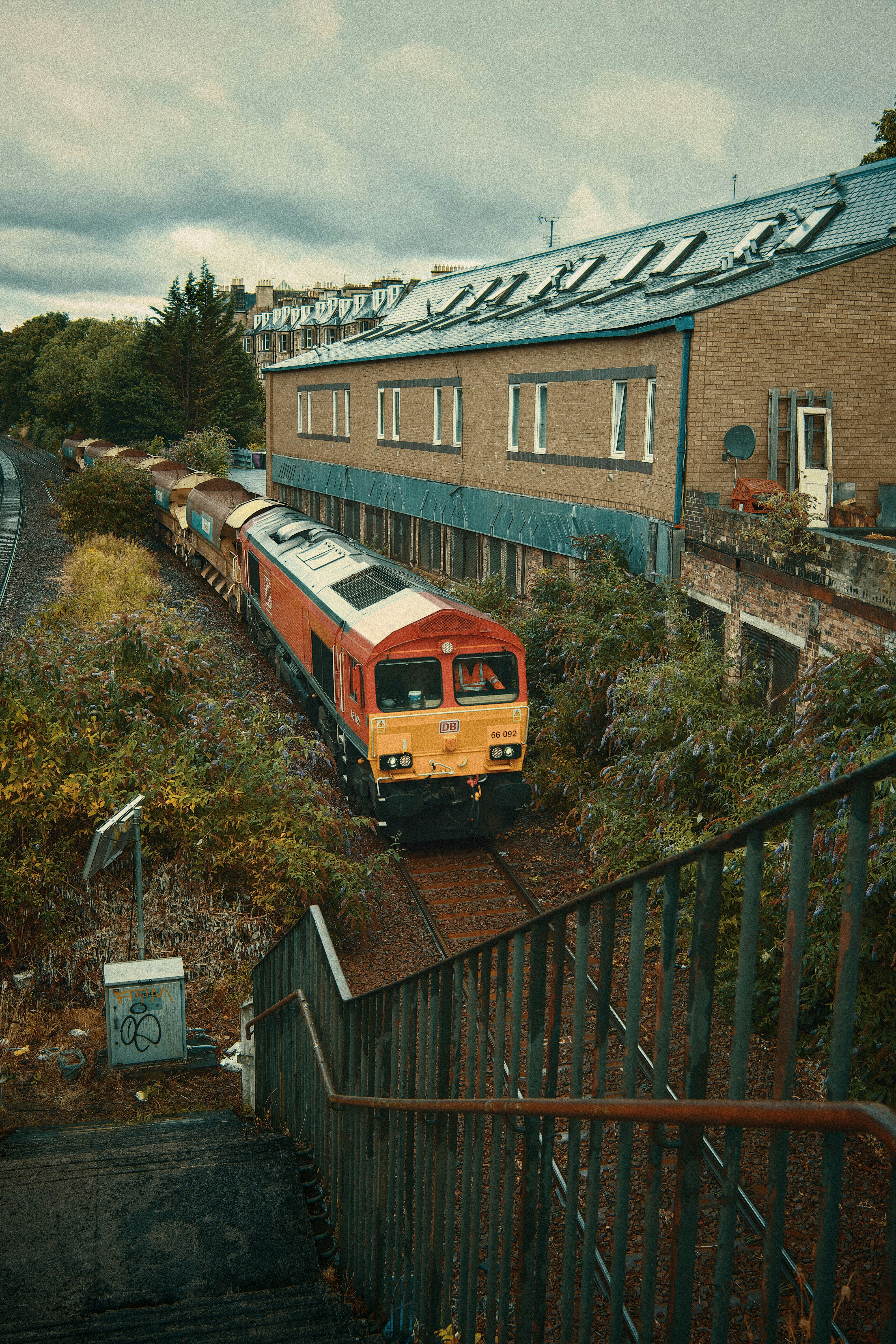 Red Locomotive at the Edge of the Quiet Yard