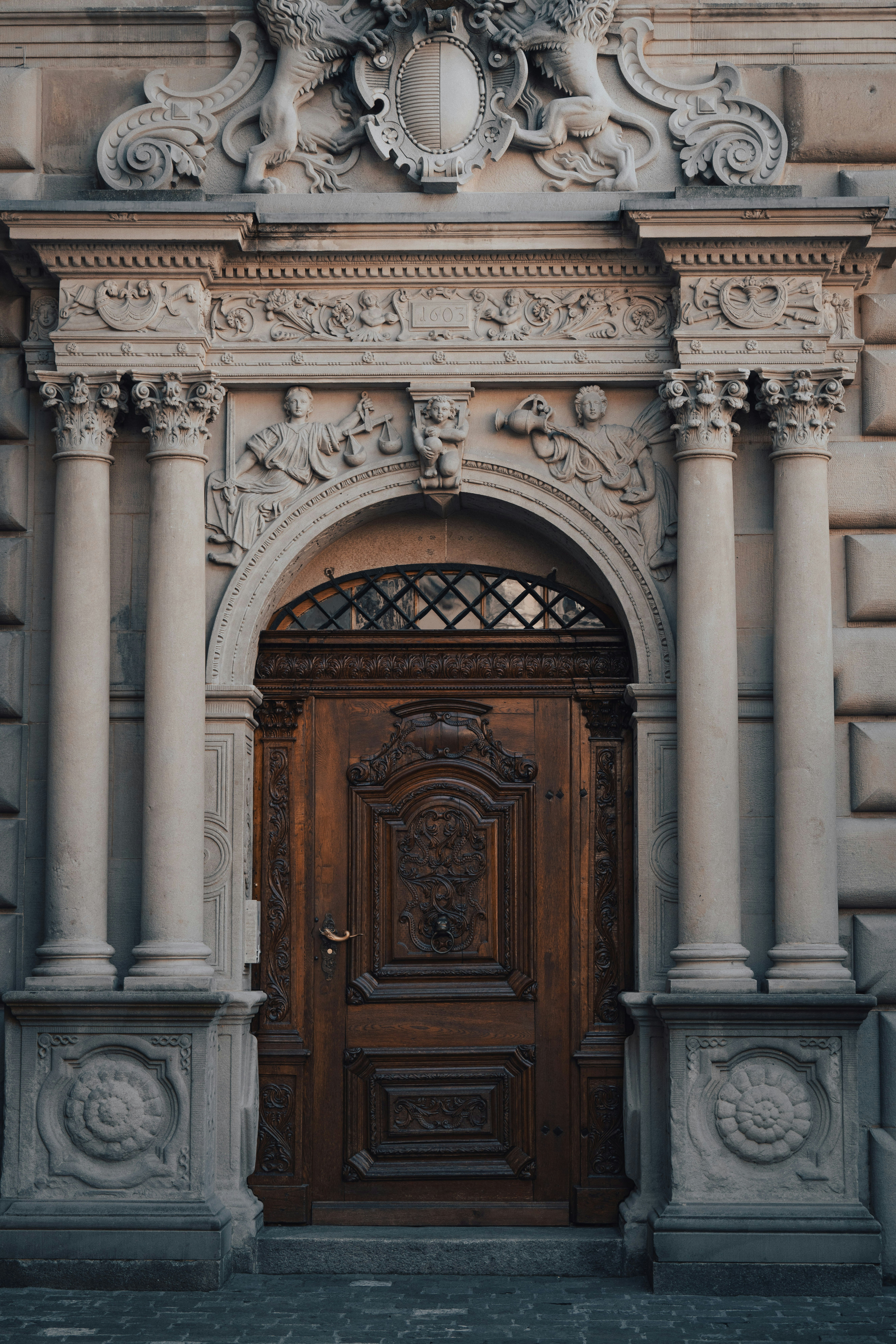 Ornate Portal: A Carved Door set within Stone Columns