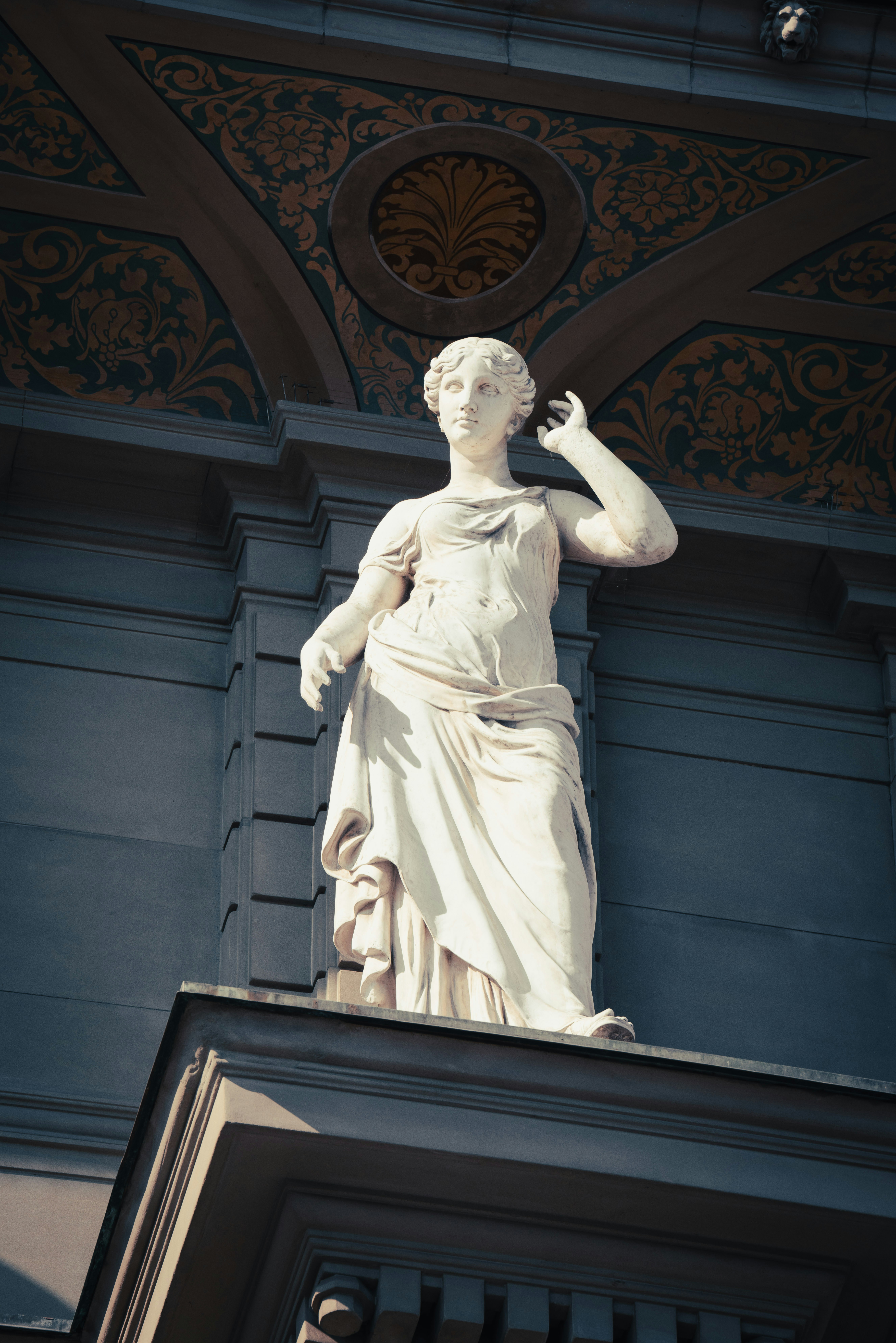 Statue at the Veranda: Classical Muse Framed by Ornate Ceiling