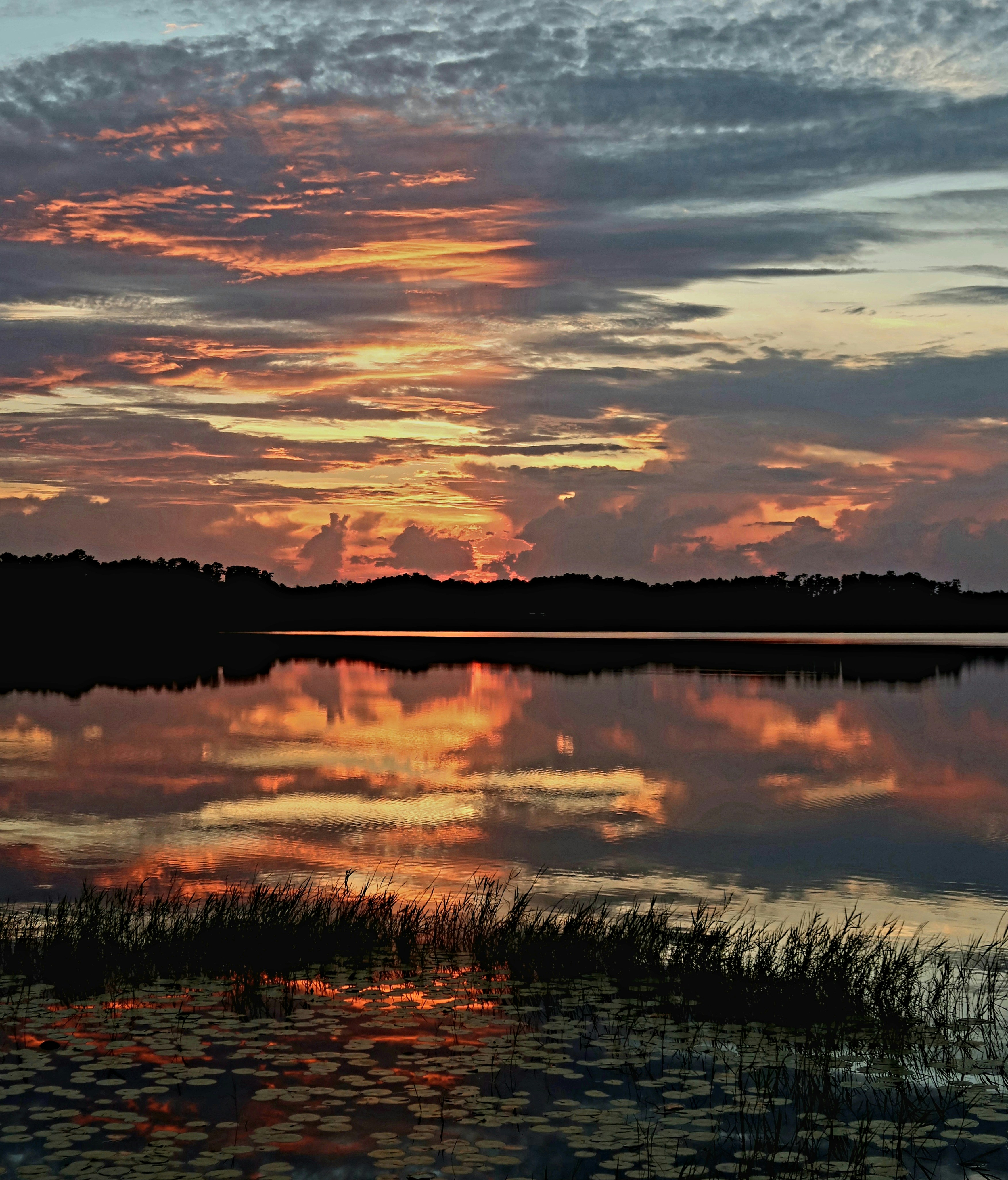 Evening Horizon Spark: Fiery Clouds Mirror a Quiet Lake