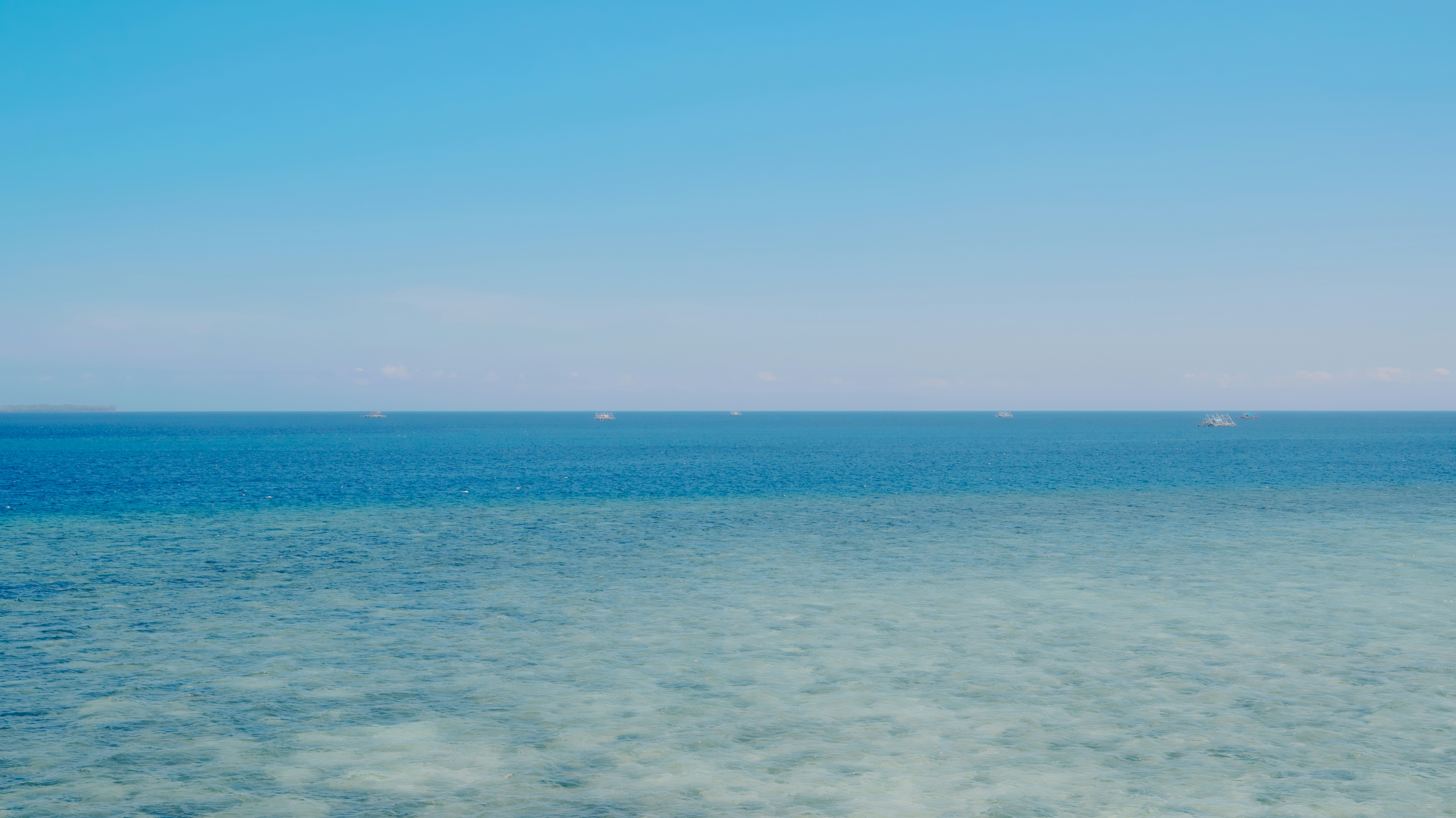 Cerulean Horizon: Calm Seas Meet a Clear Sky