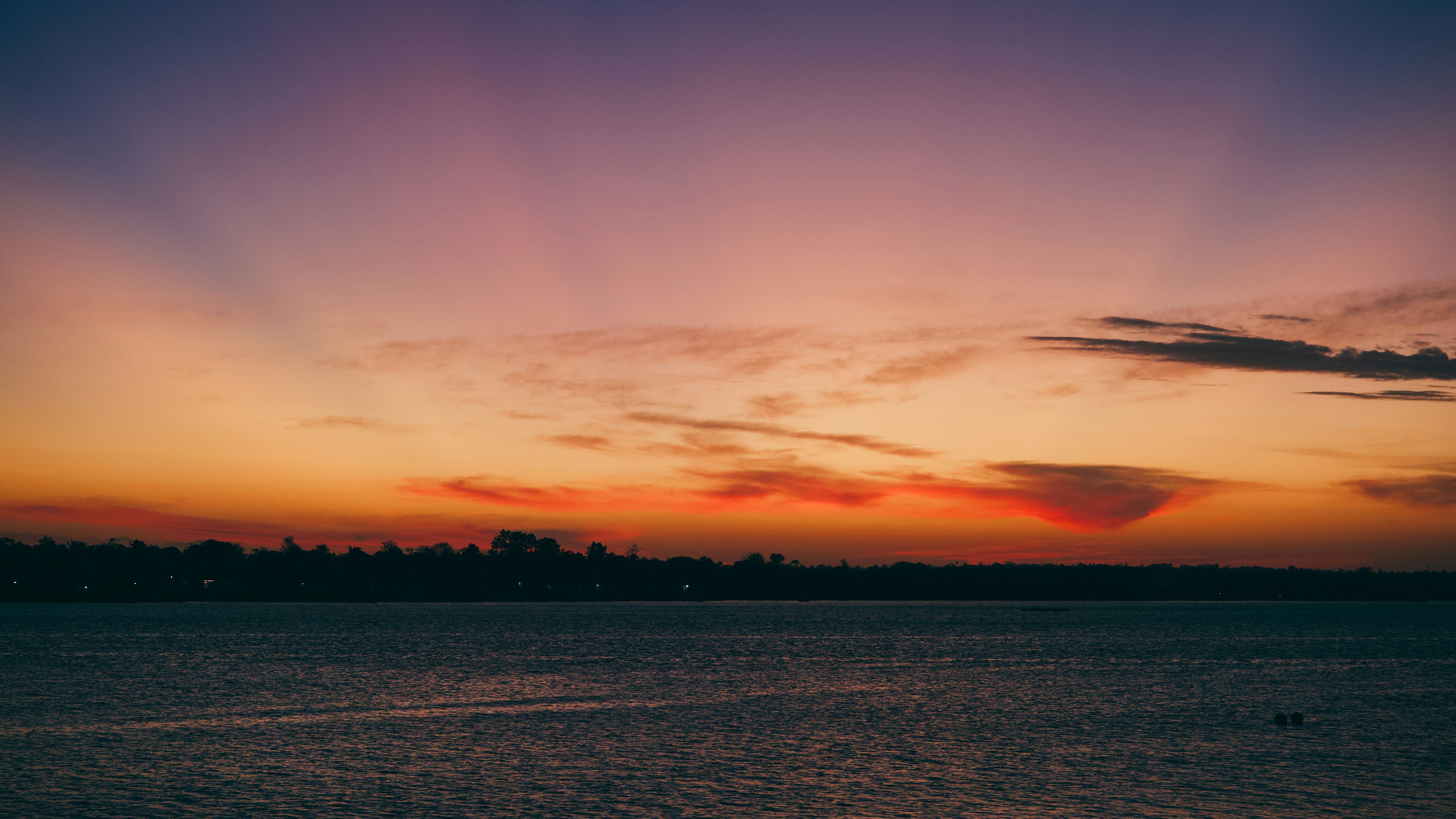 Twilight Horizon: Emerald to Apricot Over Calm Waters