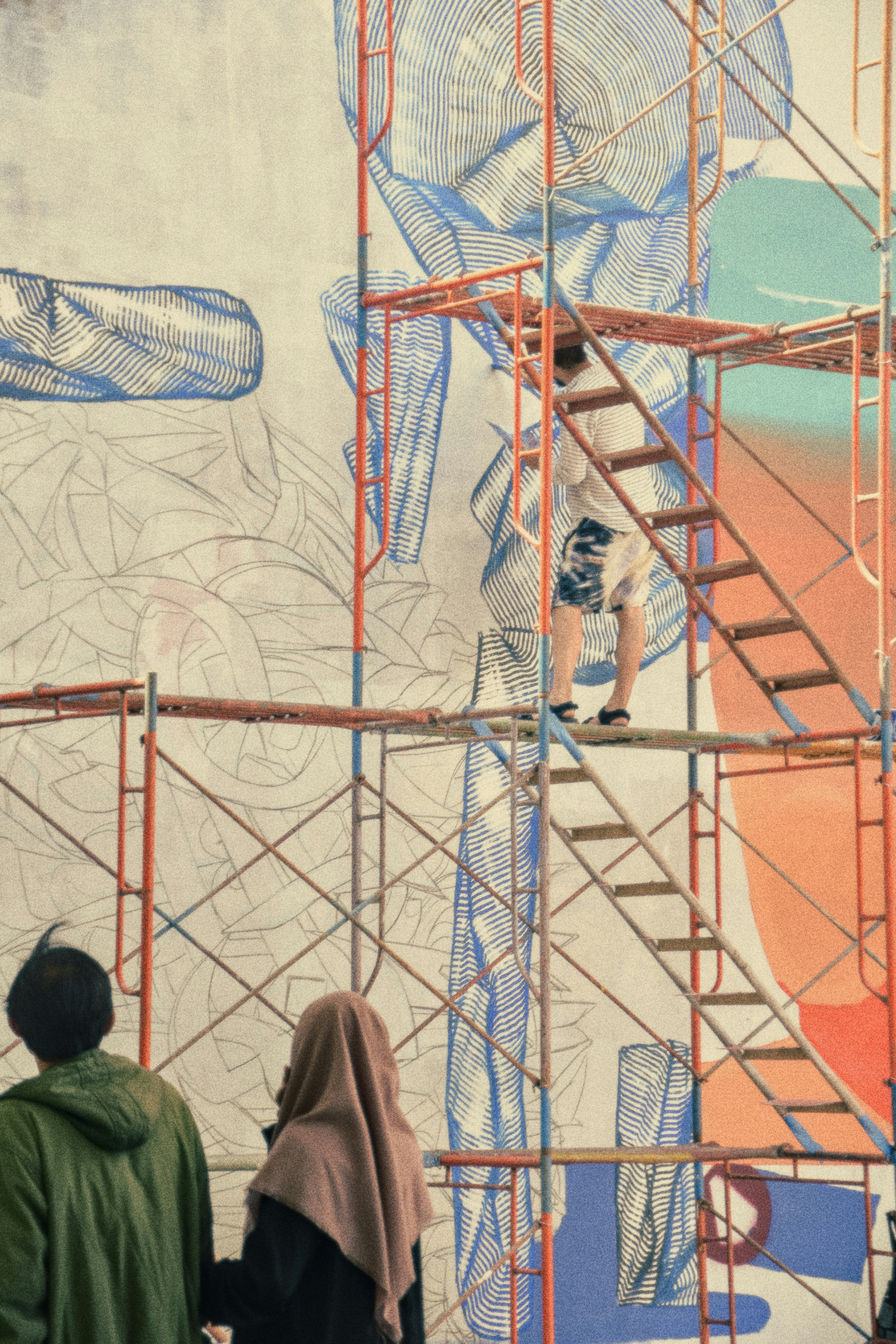 Scaffolded Canvas: A Figure Ascends the Graffiti Fresco