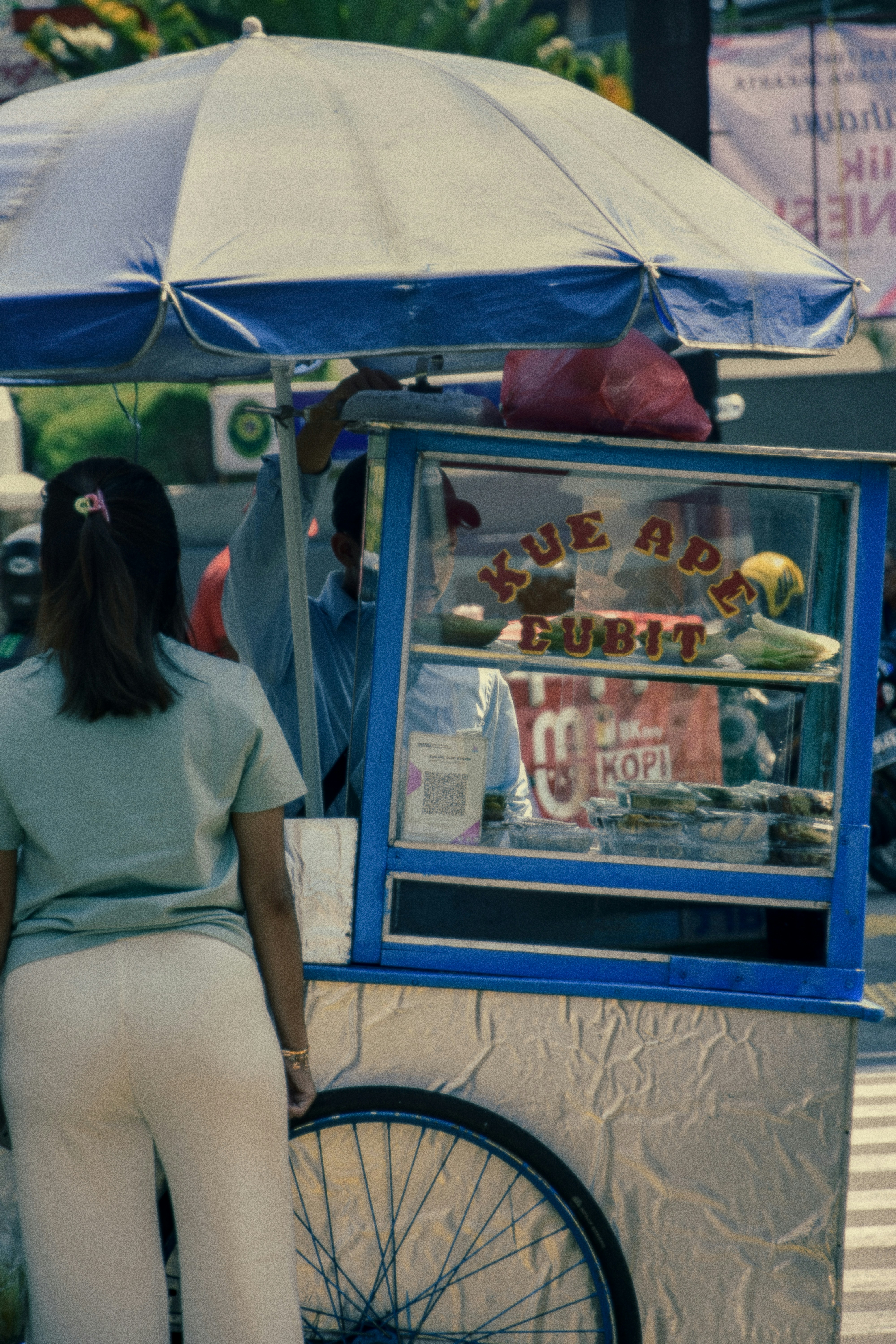 Blue Vendor Cart Under a Tinted Umbrella