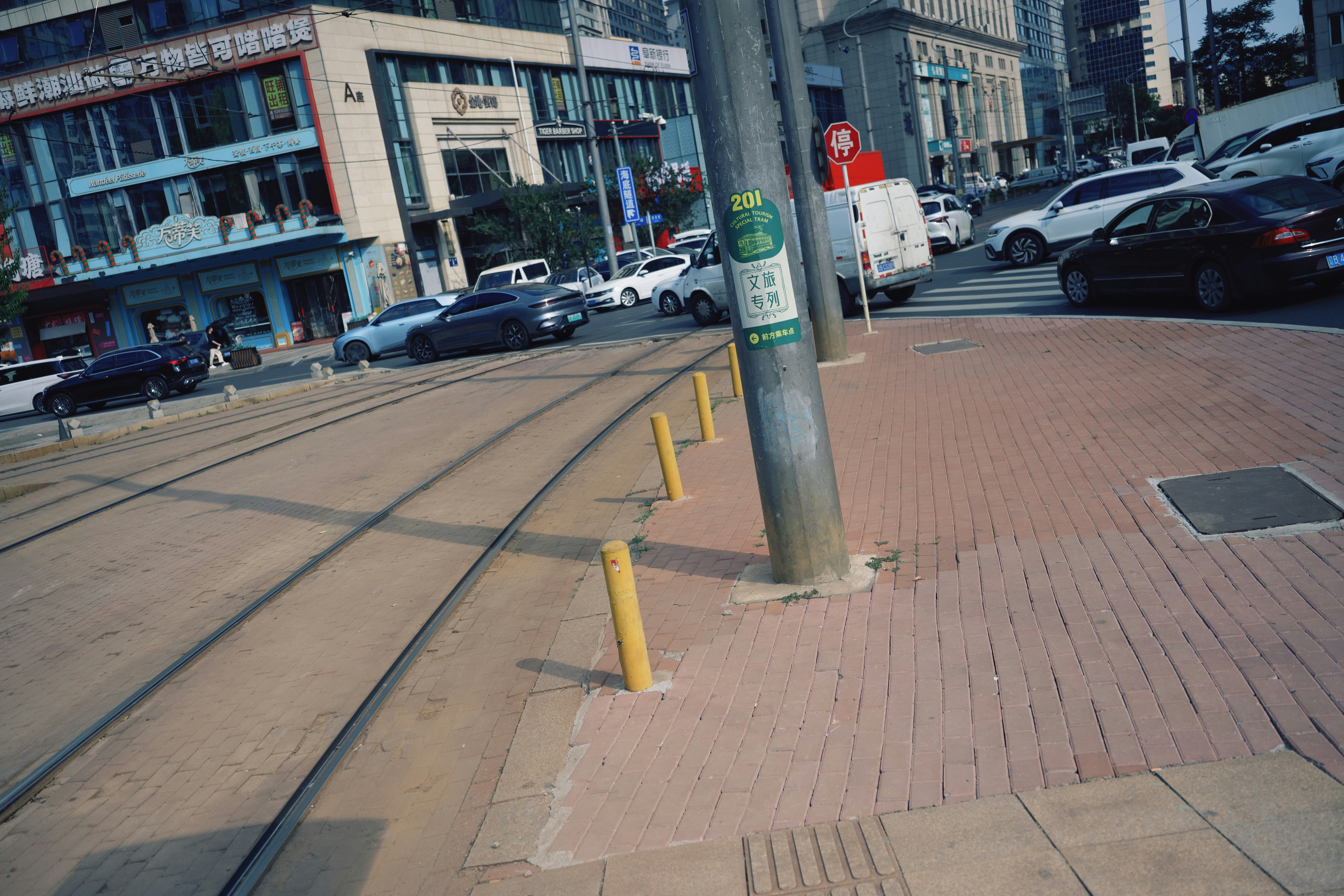 Urban Crossroads: A Tilted Street View with Trams and Pedestrian Activity