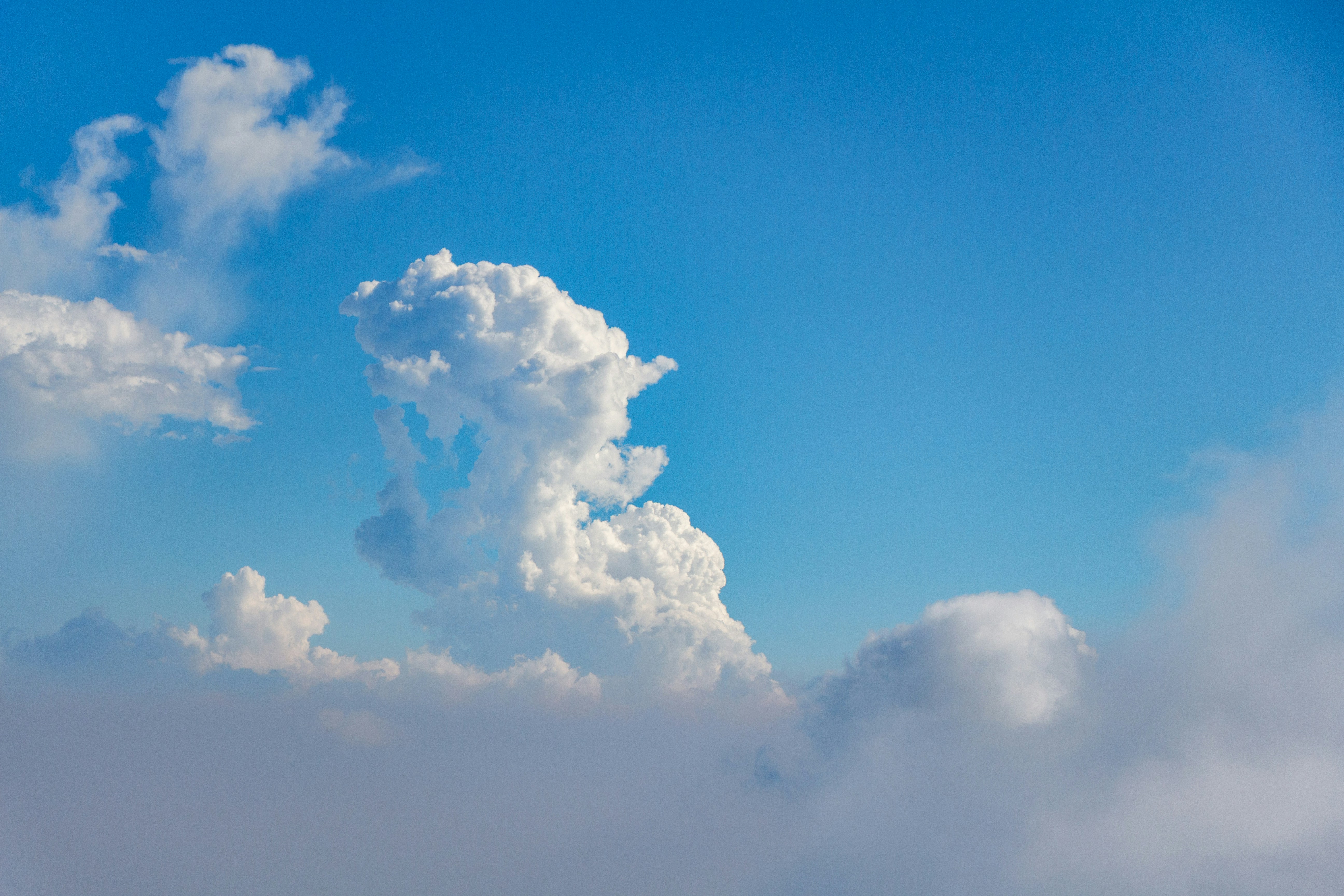 Cloud Column Rising Through a Blue Dome