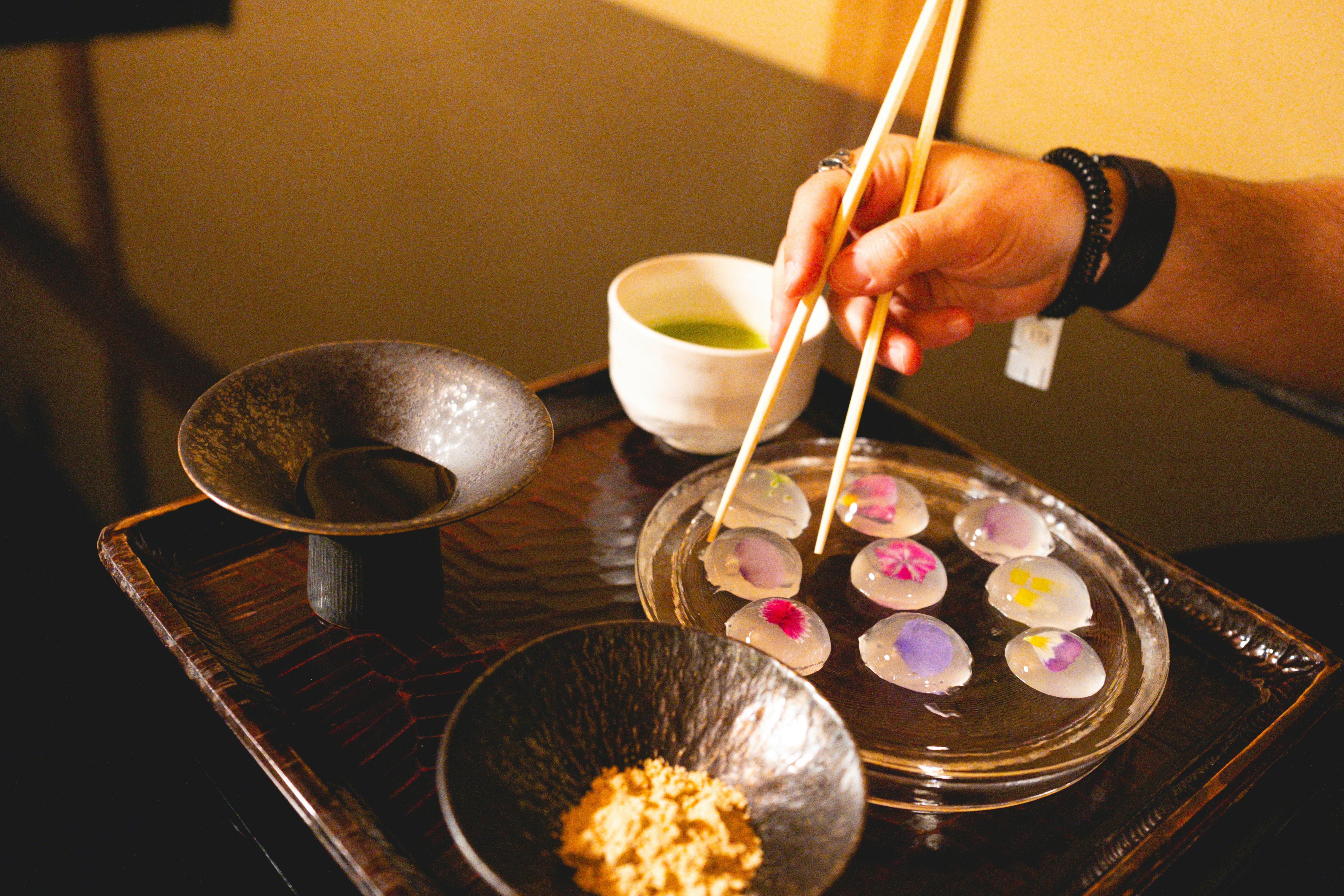 Chopsticks Hover Over a Tasting Array of Colored Sweets