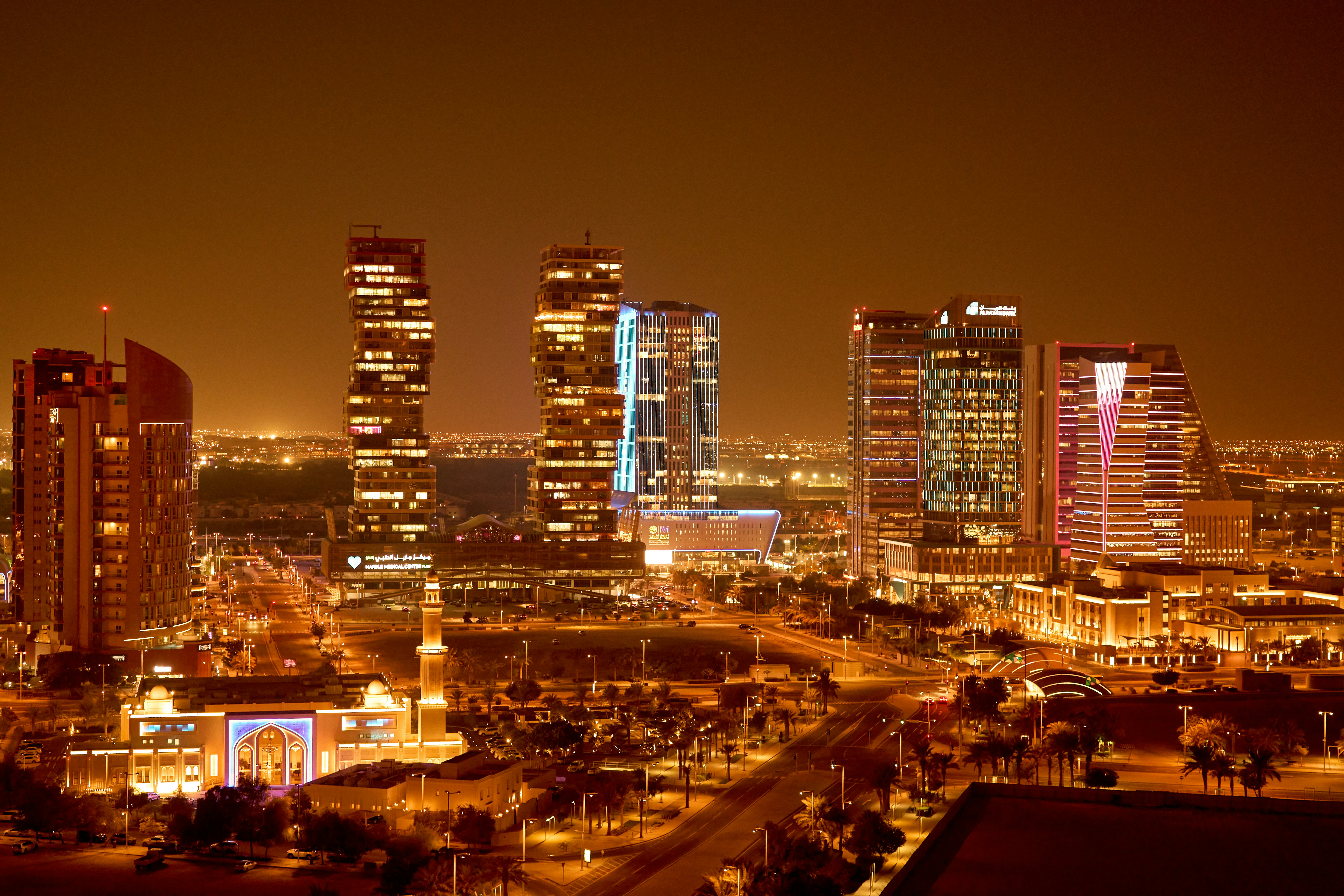 Midnight Skyline: Glass Towers Luminesce Over a Desert City