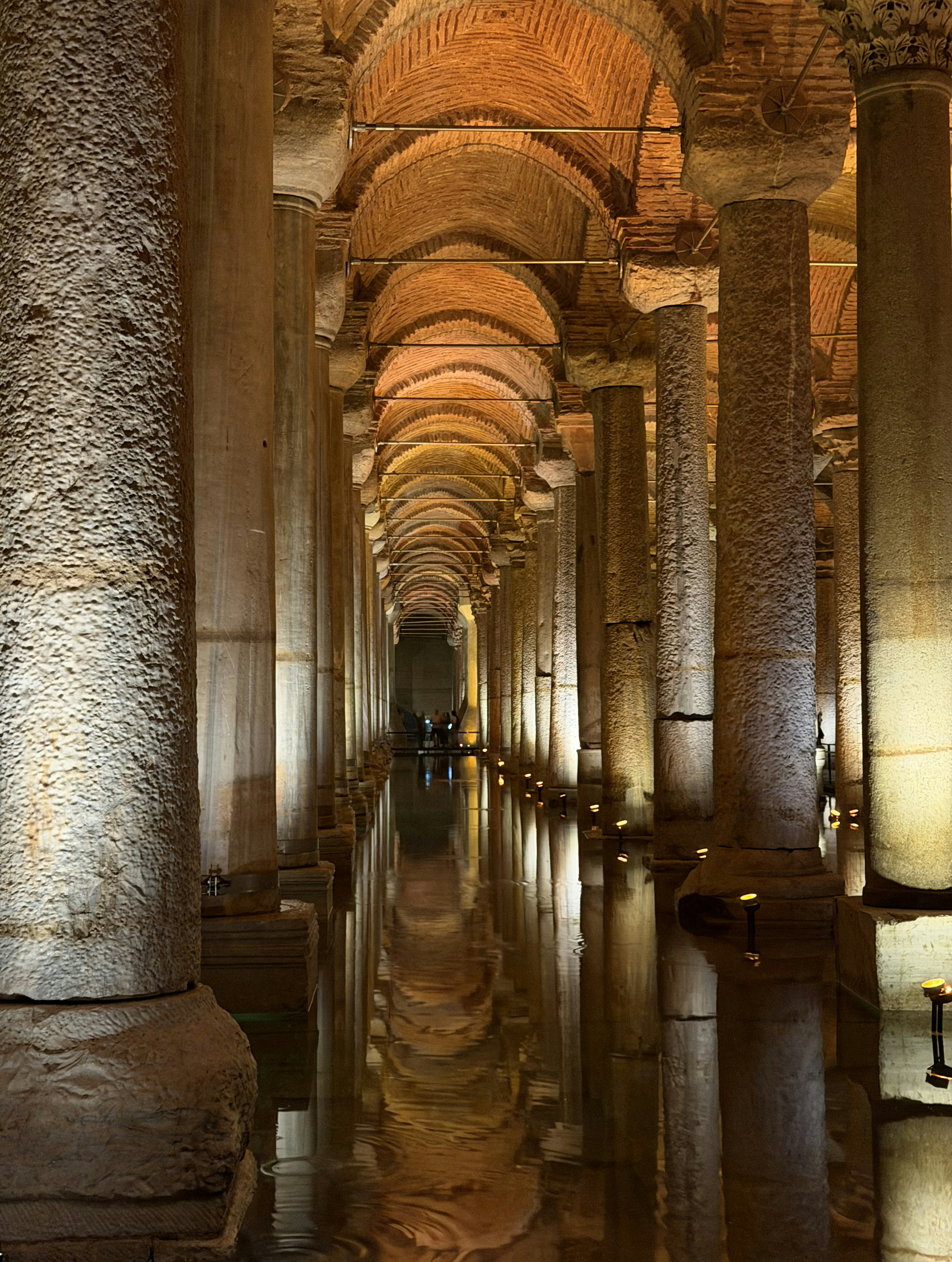 Stone columns in the Basilica Cistern reflecting in dark water in Istanbul