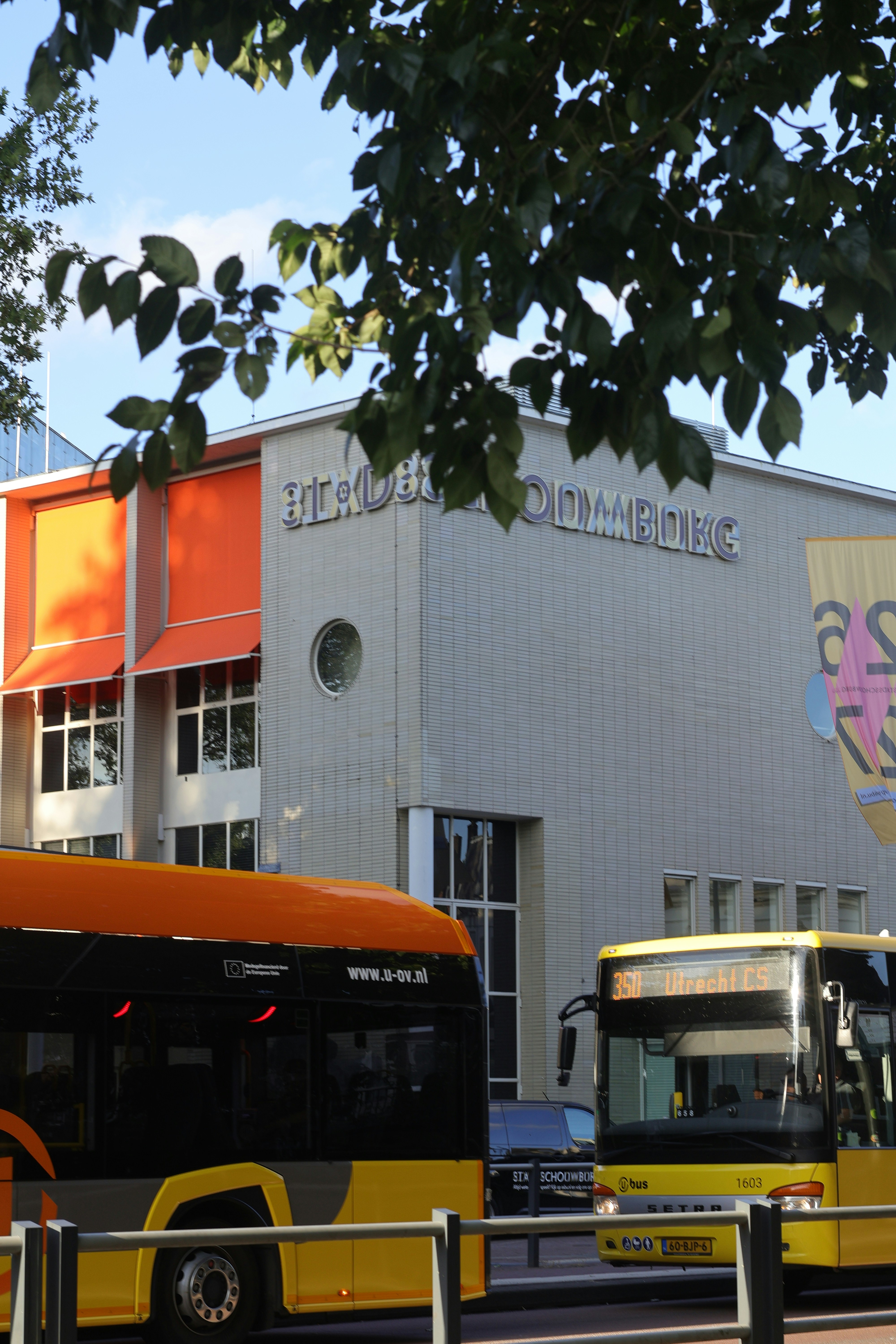 Orange and Yellow Buses at Urban Transit Hub