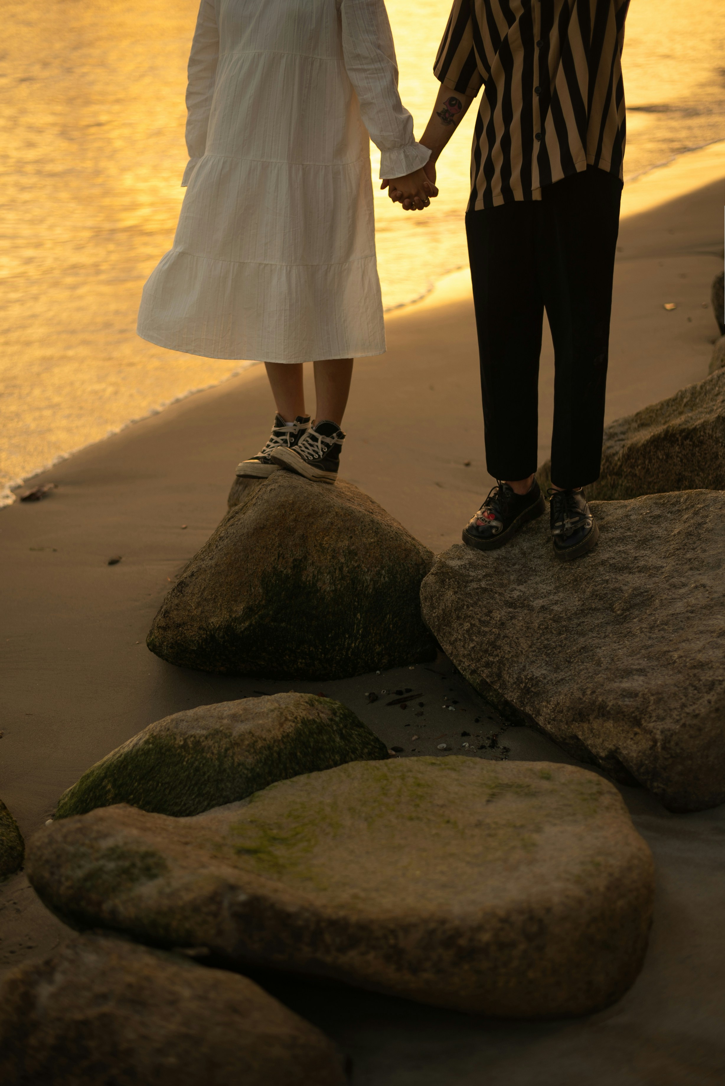 Holding Ground: Partners Step Onto the Rocks at Sunset
