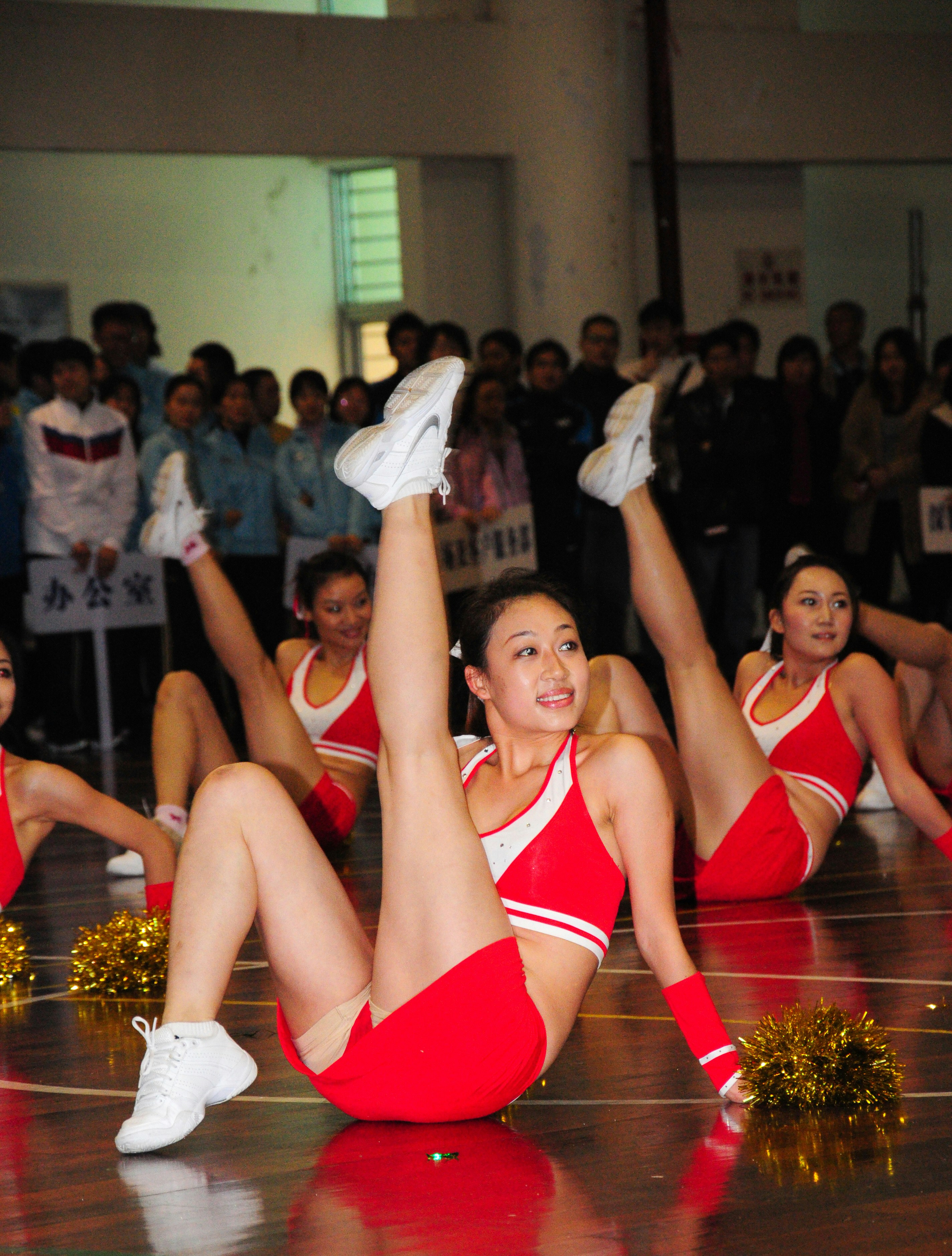 Red Zest: Dynamic Cheering Duo in a Gym Split