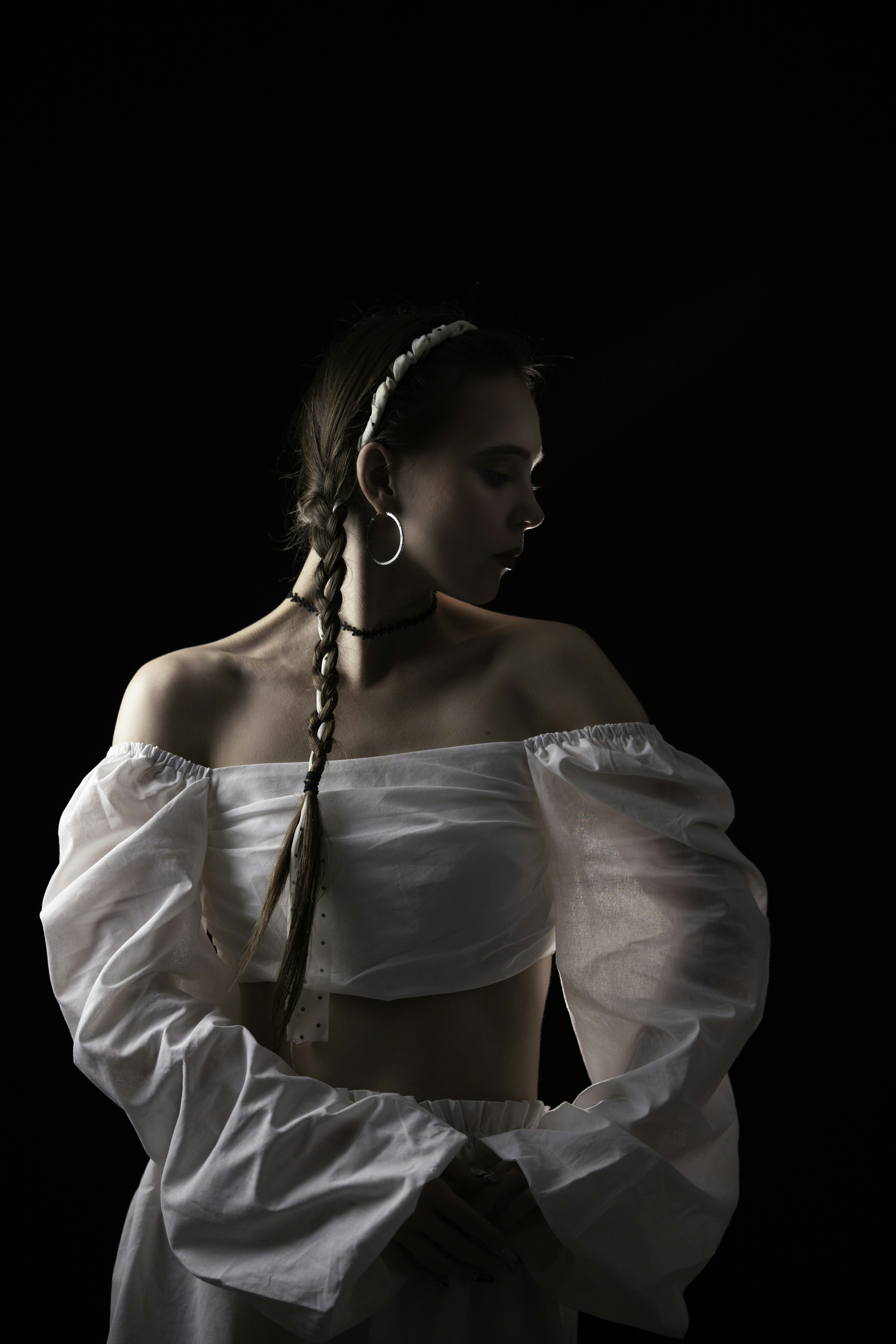 Braided light: a moody off-shoulder portrait in velvet-black
