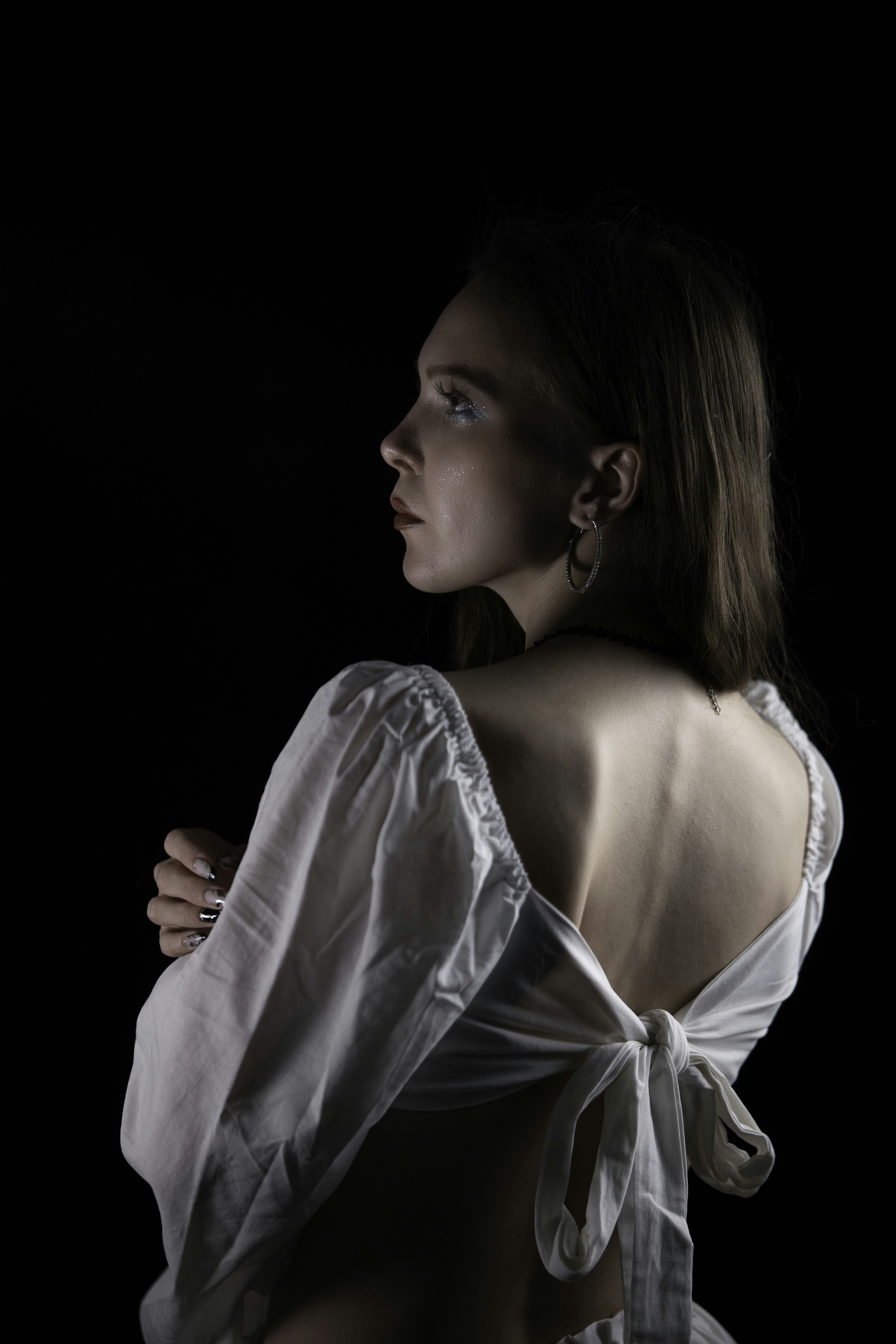 Backlit Elegance: The Open-Back Pose