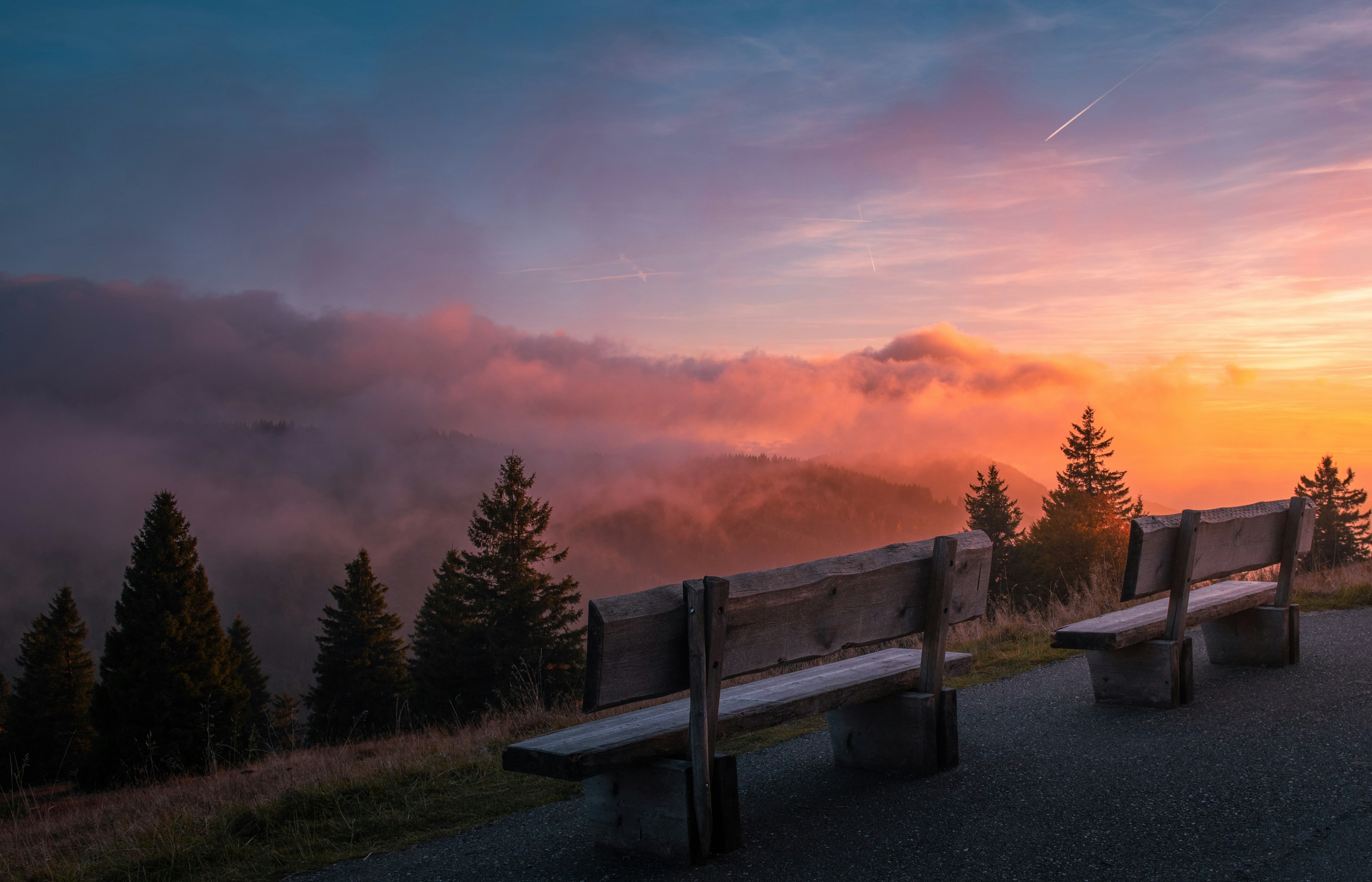 Sunset Over the Ridge: Weathered Benches and a Sky on Fire