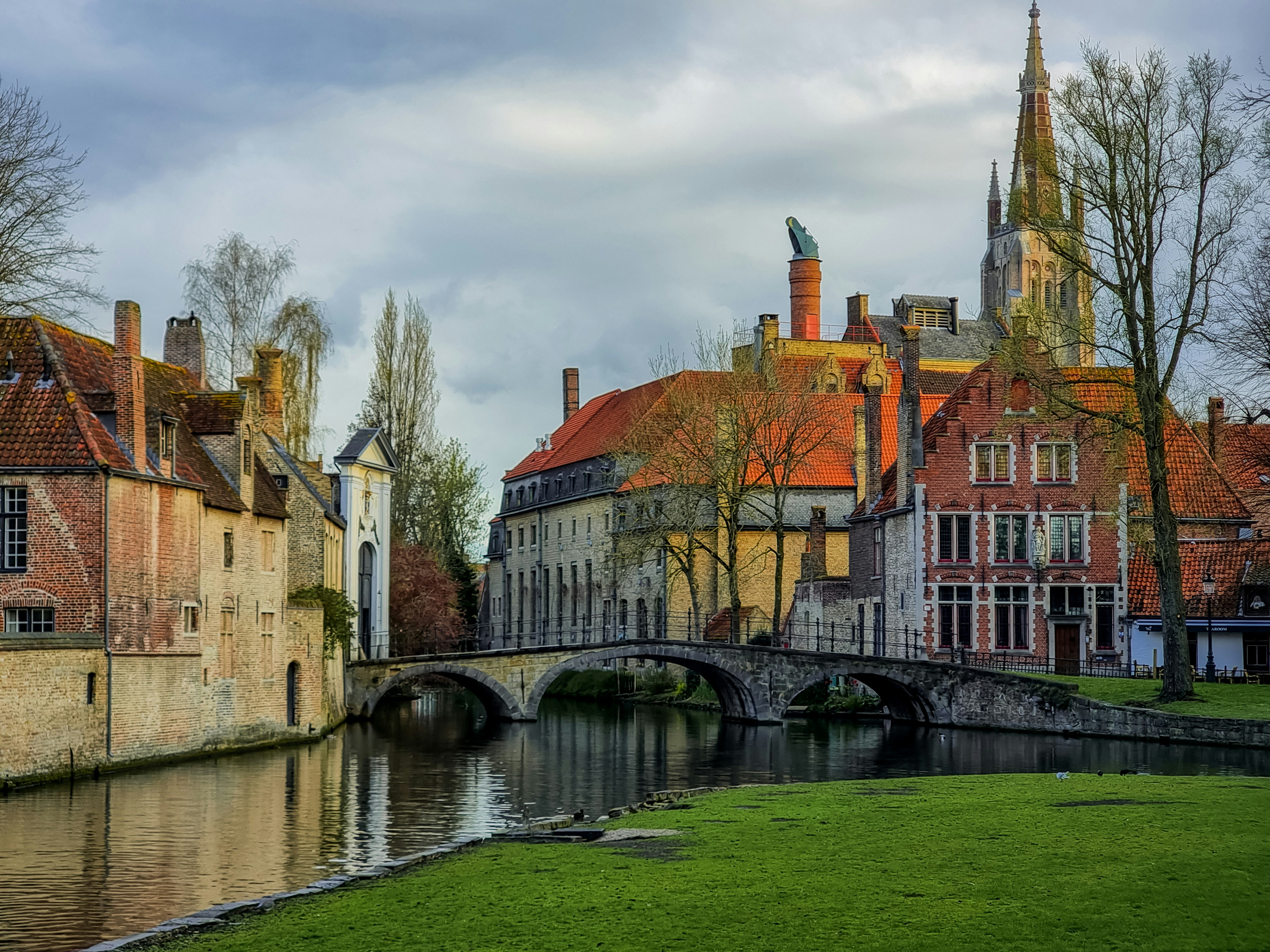 Bridge and Riverside Row: A Quiet Flemish Canal Scene