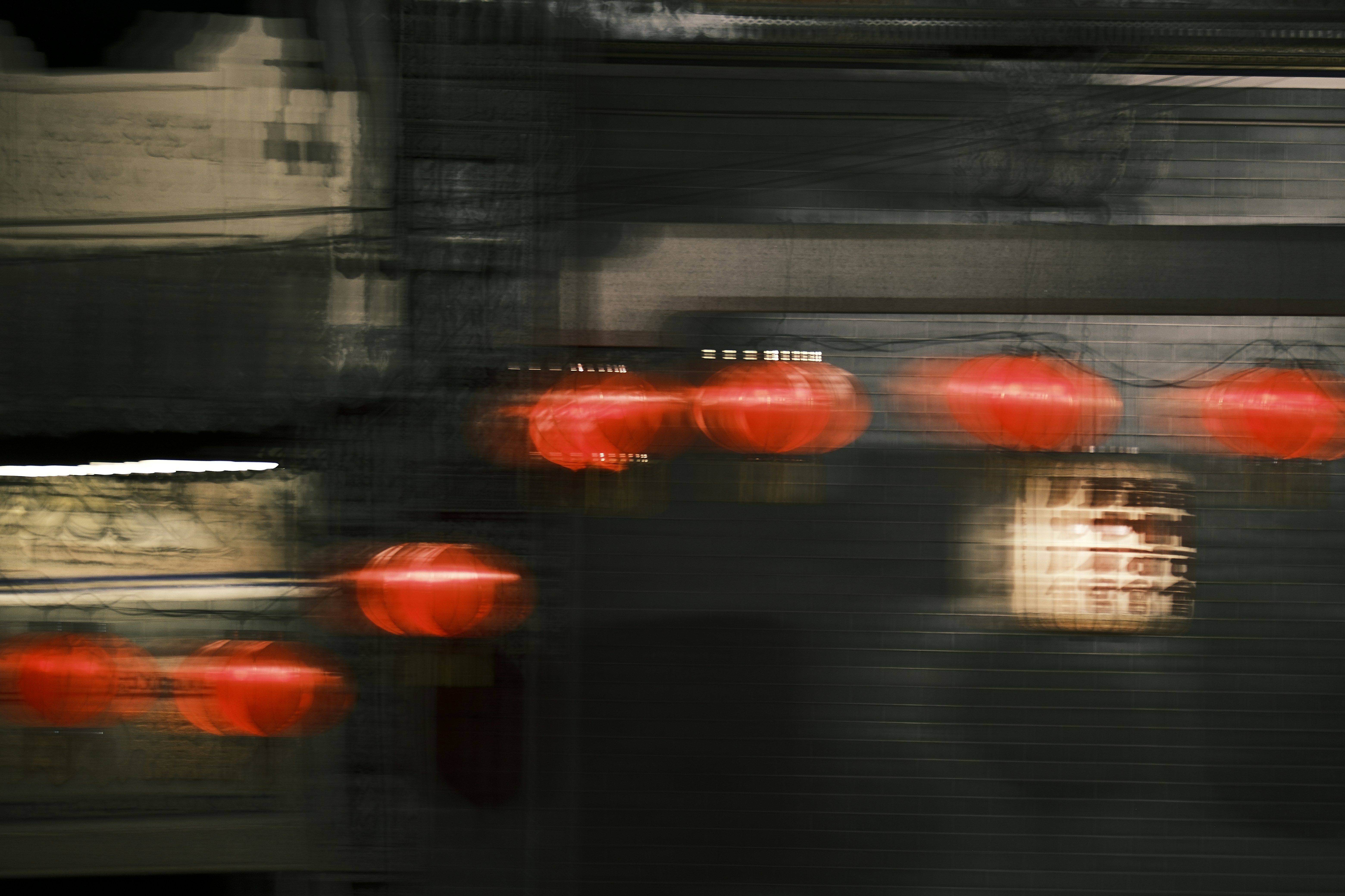 Red Lanterns in Motion: A Night Street Blur