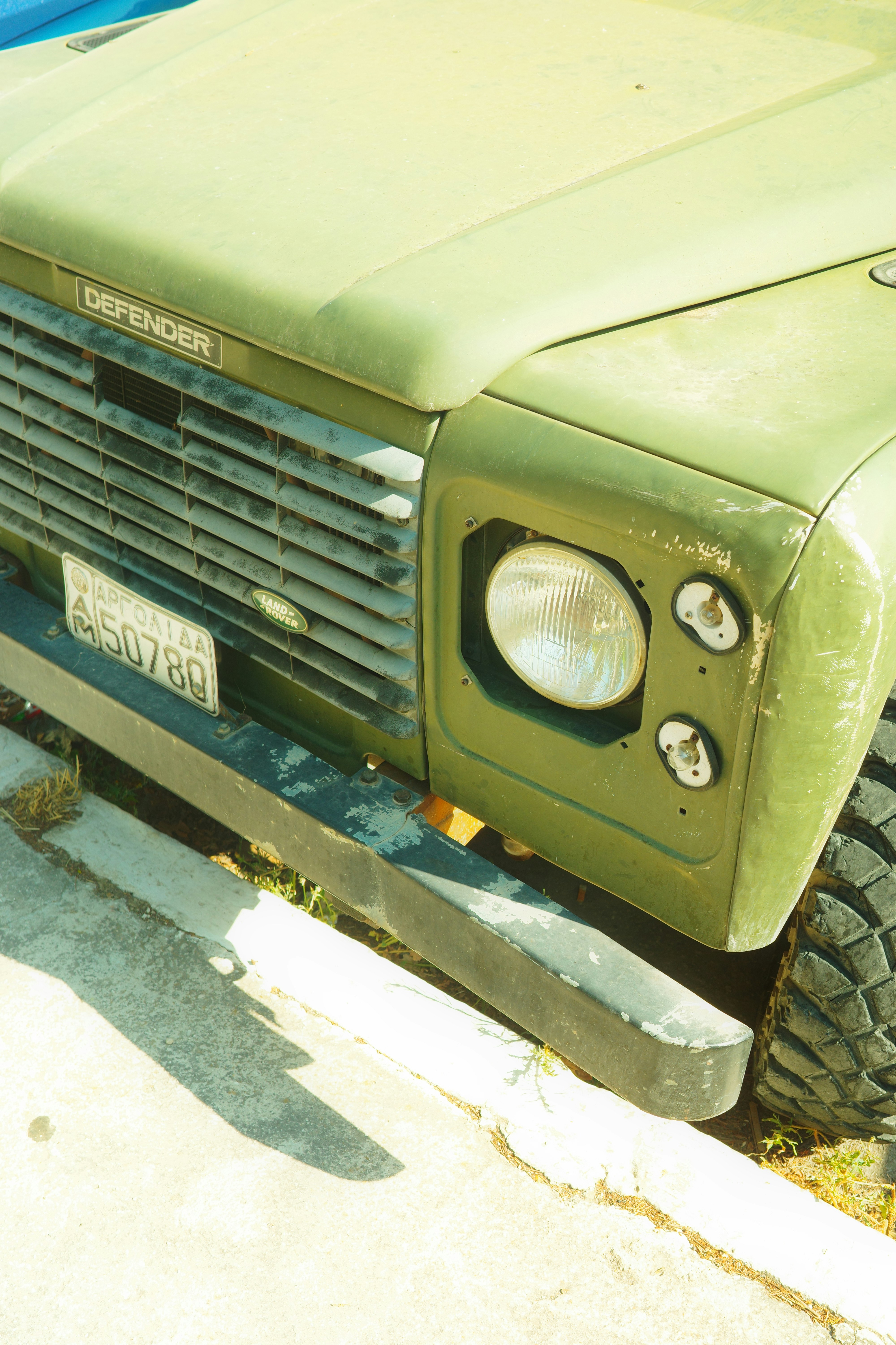 Dusty Defender: A Weathered Green Icon in Sunlit Detail