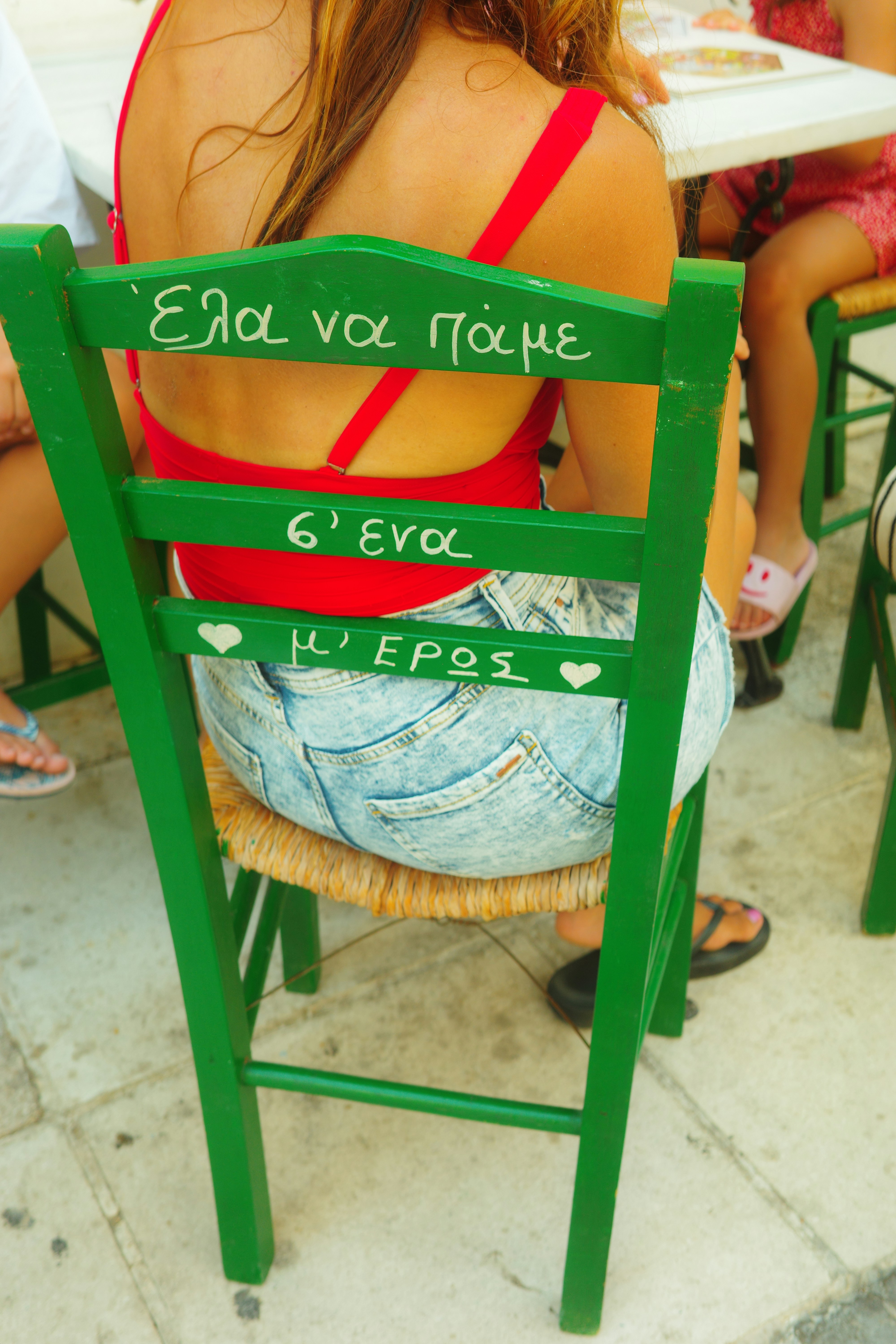 Green Chair Back Portrait with Red Swimwear