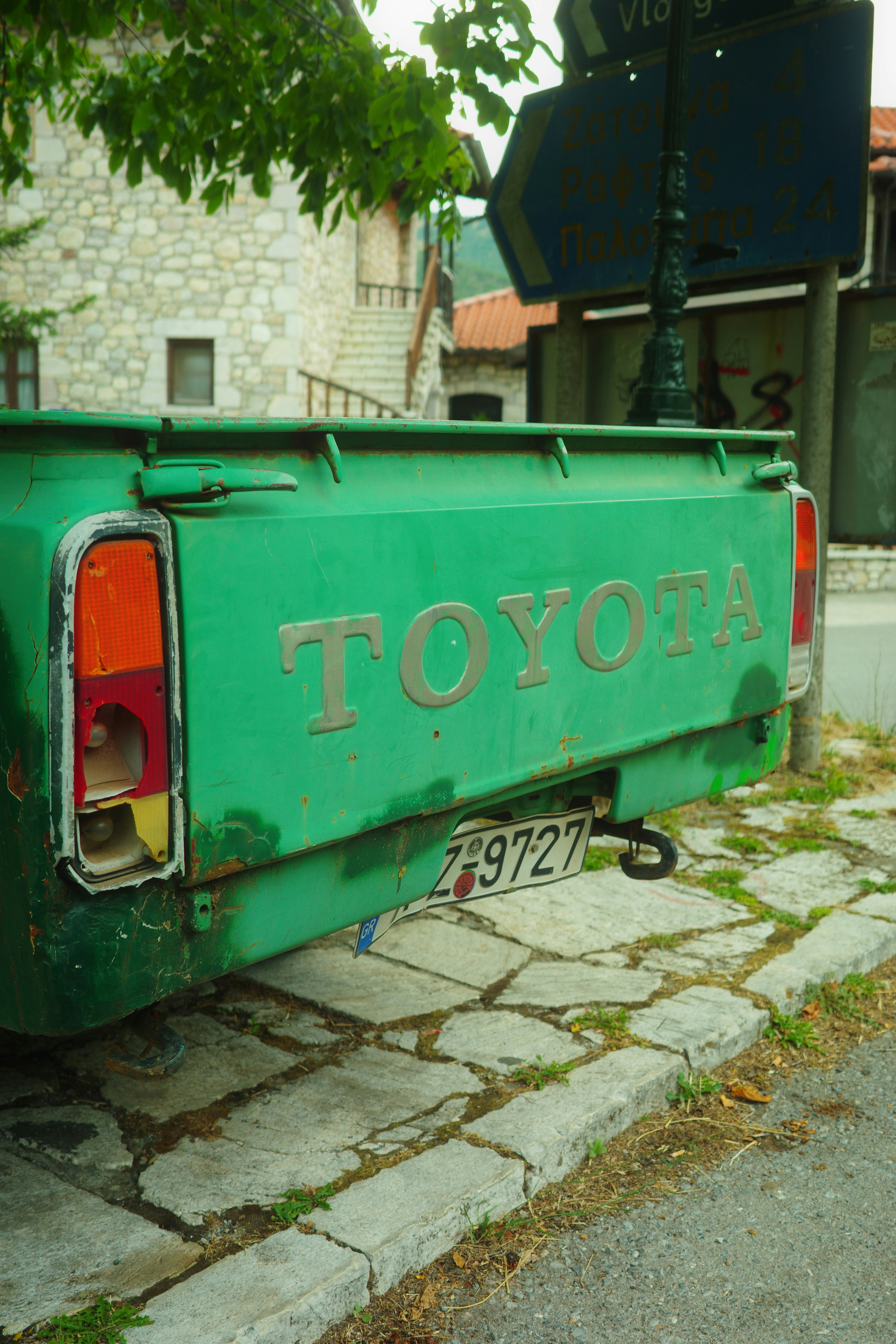 Green Pickup in Rustic Village