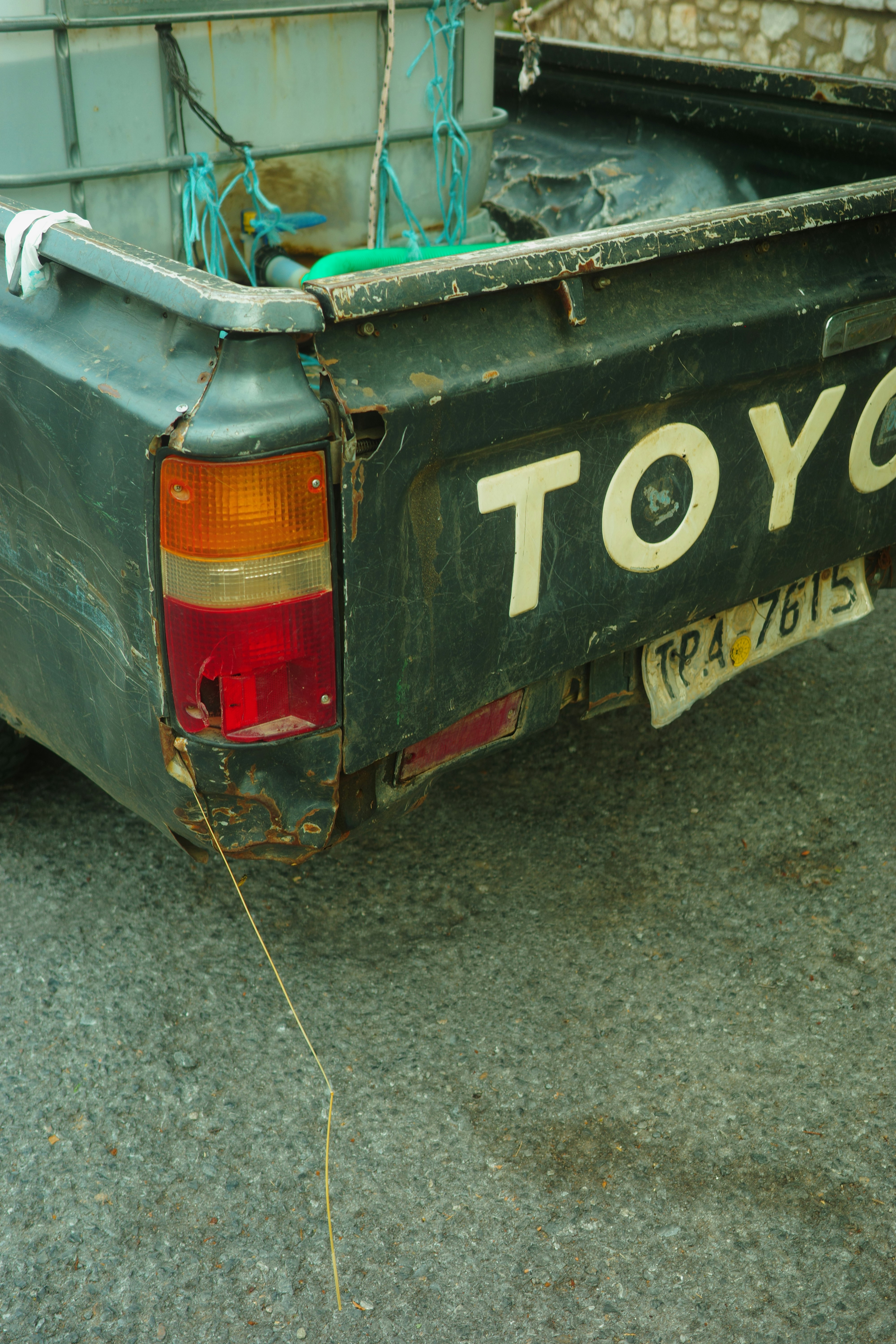 Rugged Tailgate Echo: A Weathered Toyota Pickup at Rest
