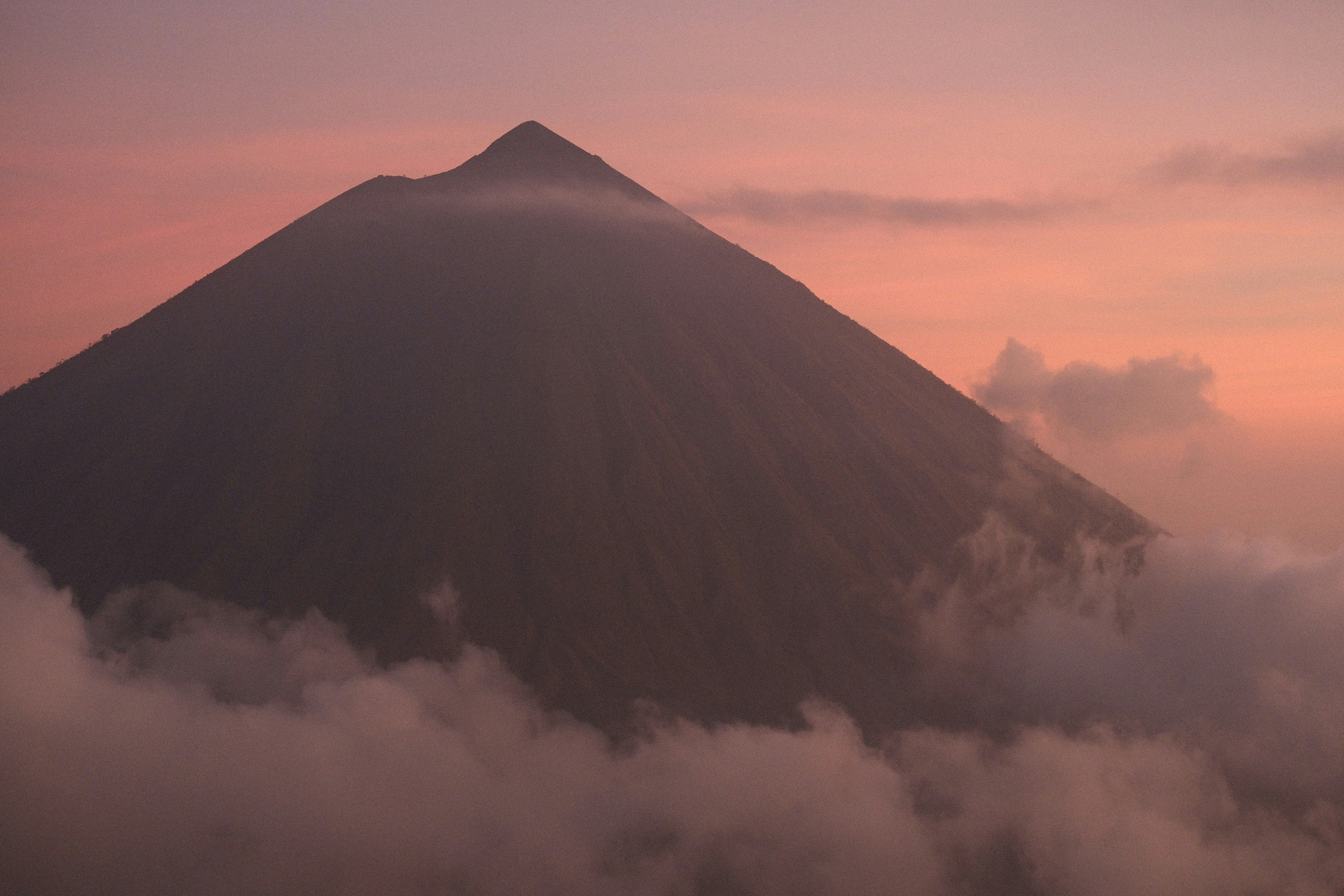 Dawn Silhouette: A Volcano Emerges from Mist