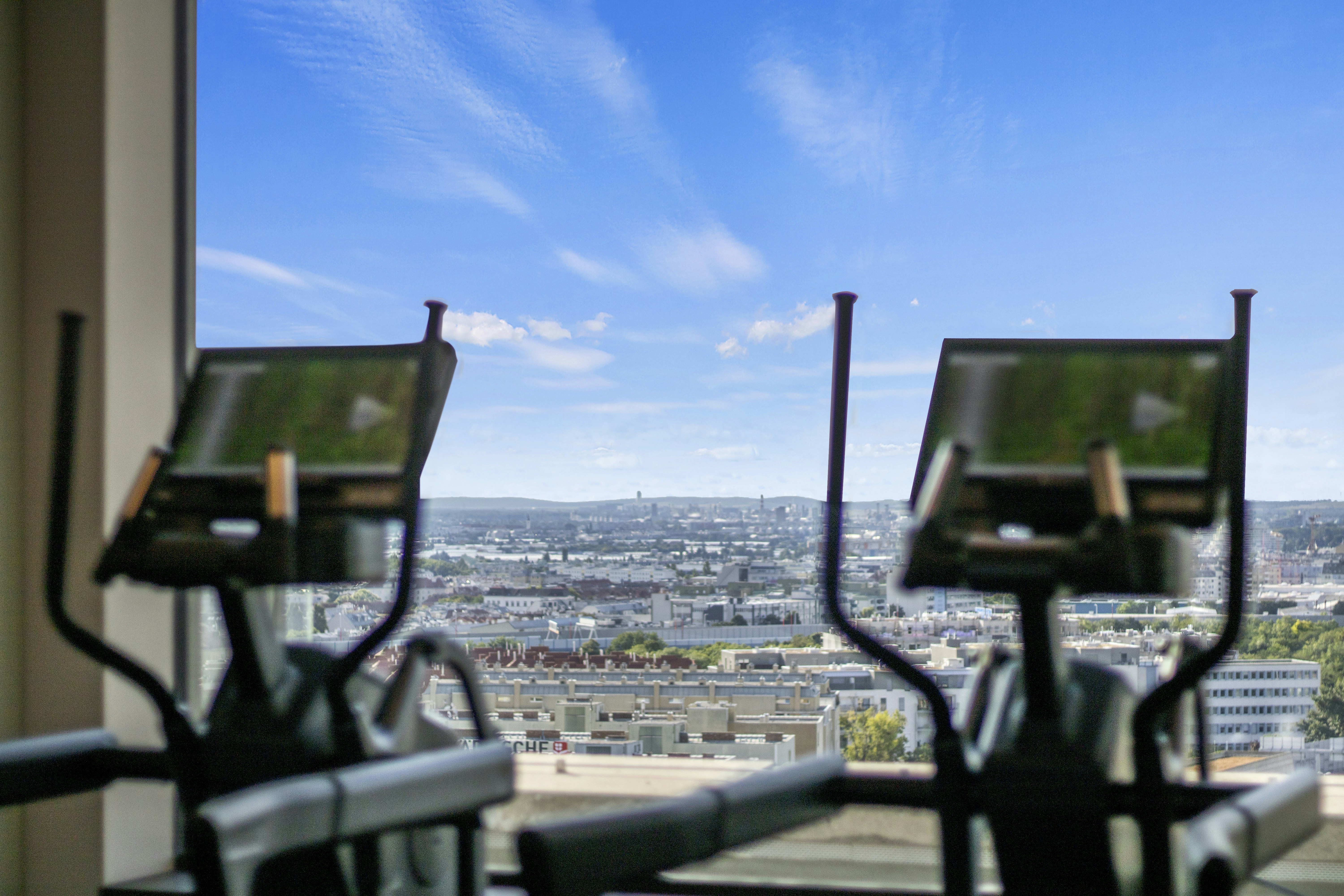 Cityscape Through Cardio Machines: Morning View from the Gym