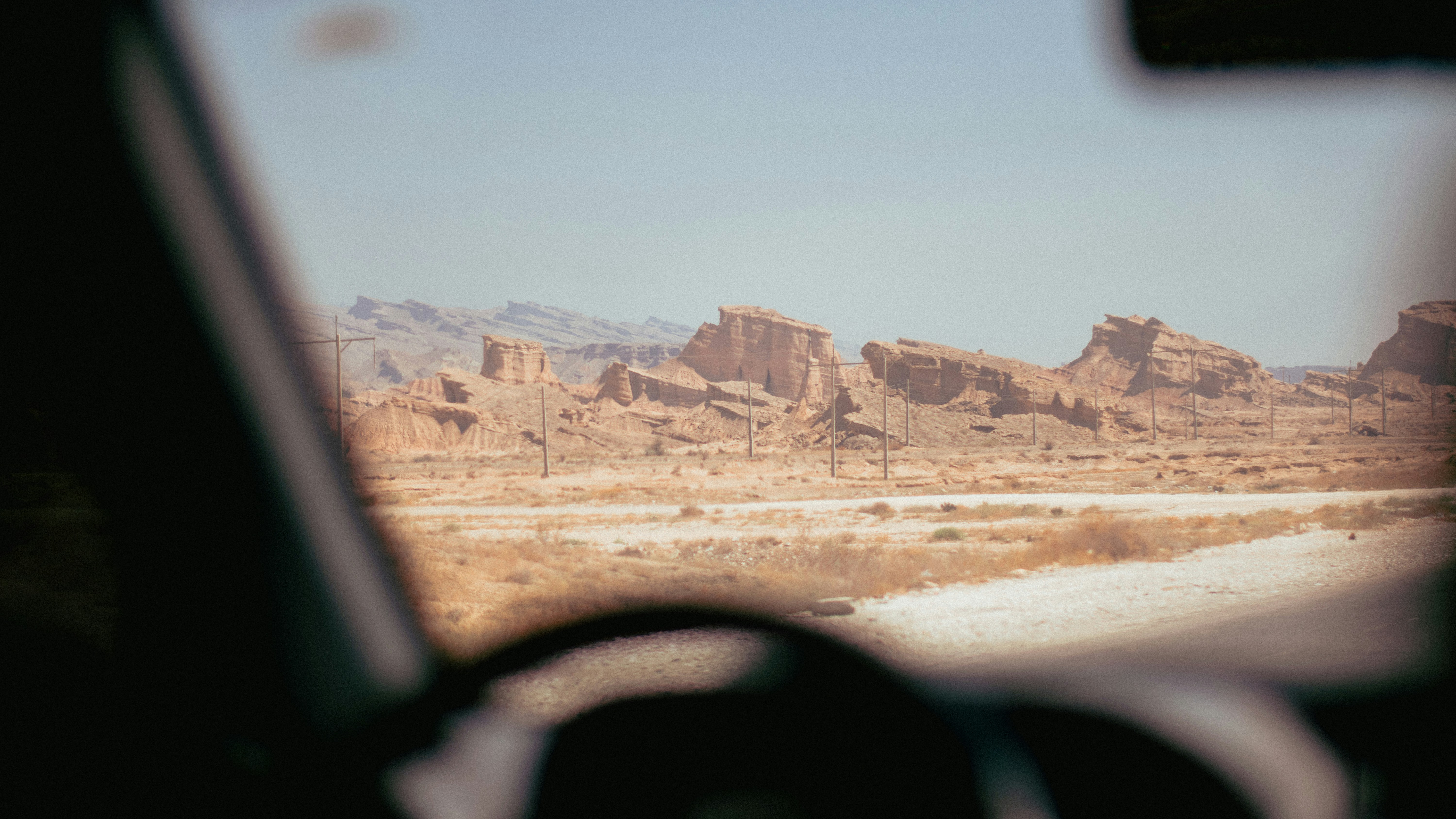 Desert Highway Through Car Window: Granite Formations on the Horizon