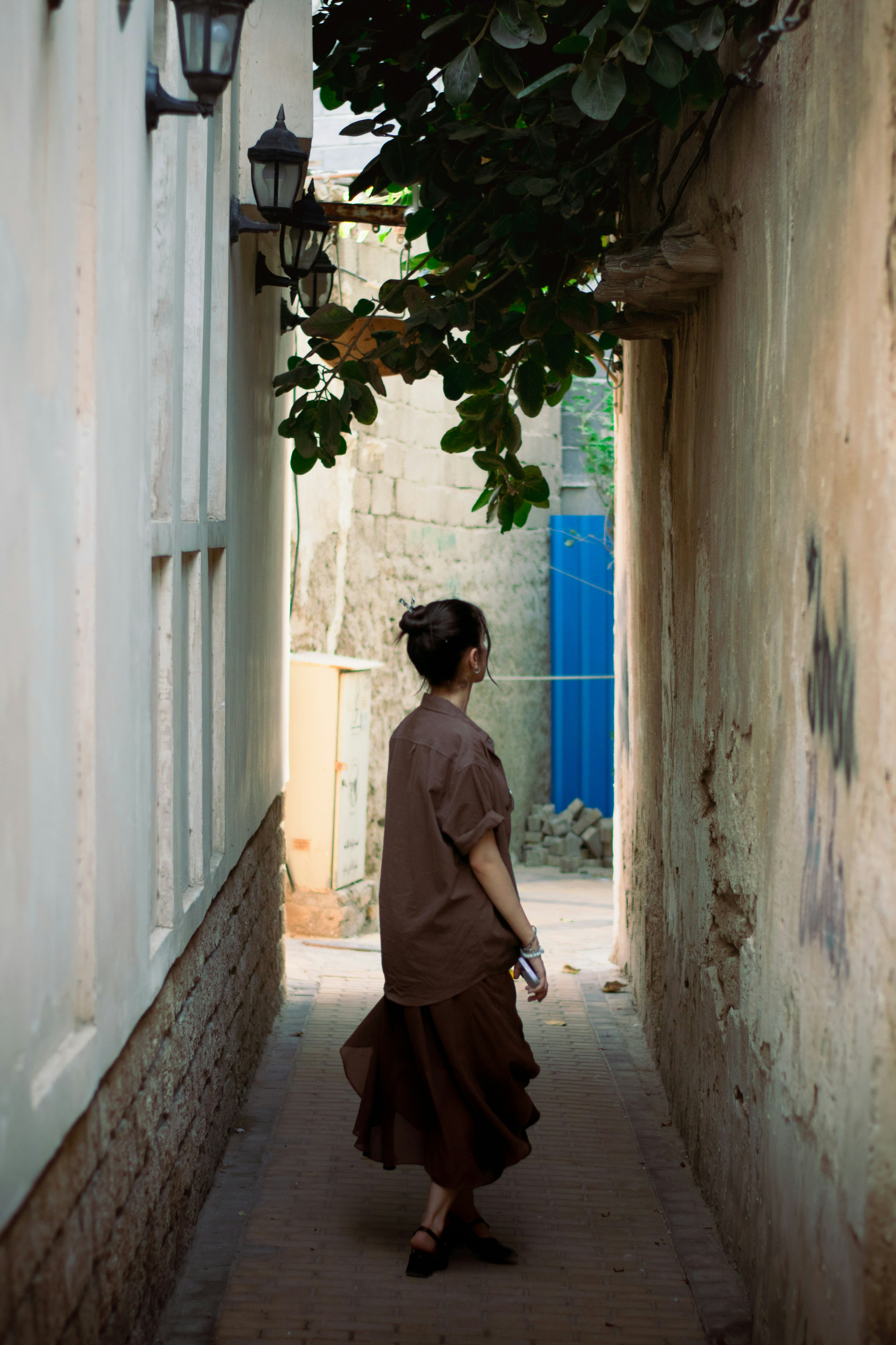 Narrow Alleyway Passage with a Paused Moment
