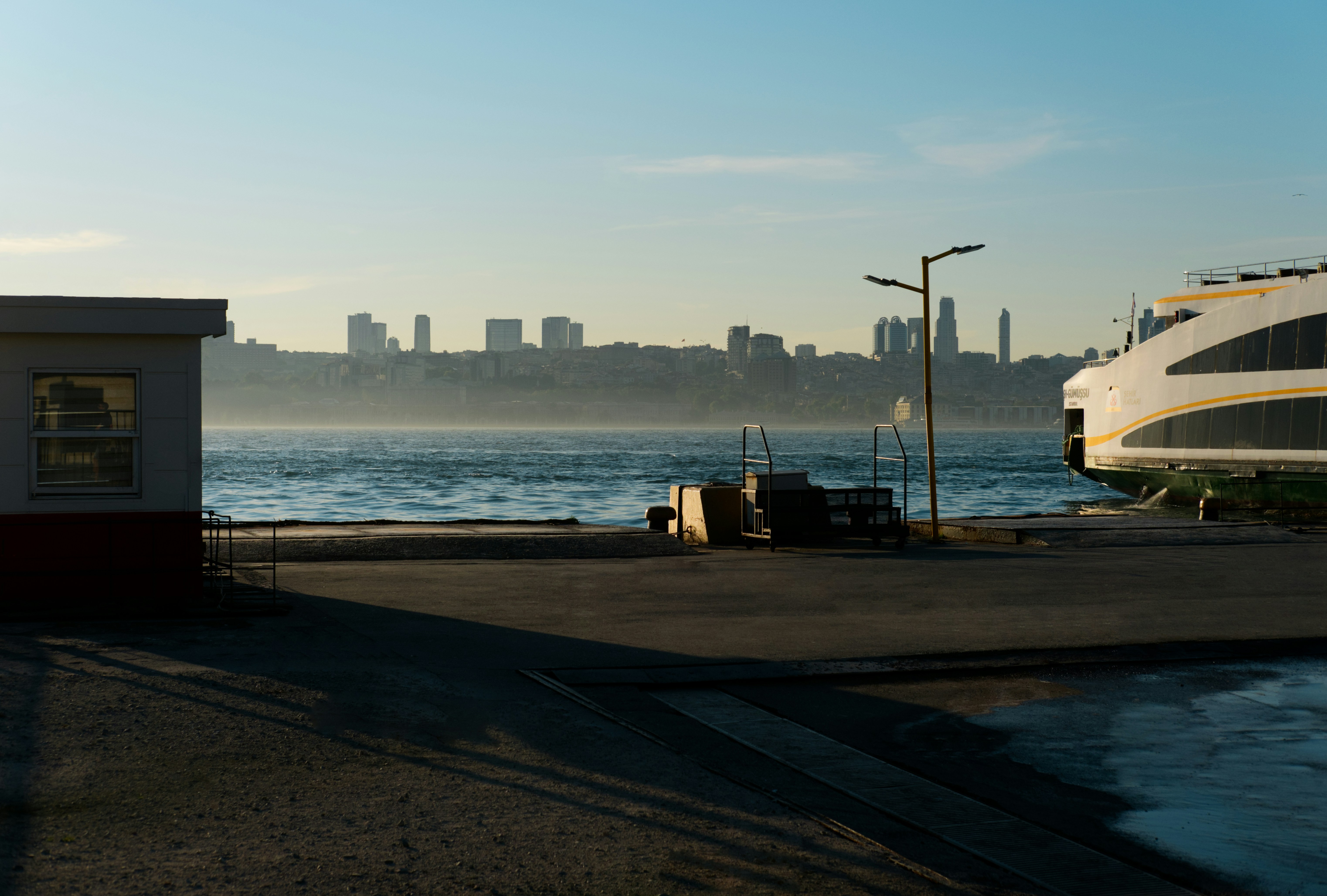 Harbor Interface: Train, Pier, and Distant Skyline