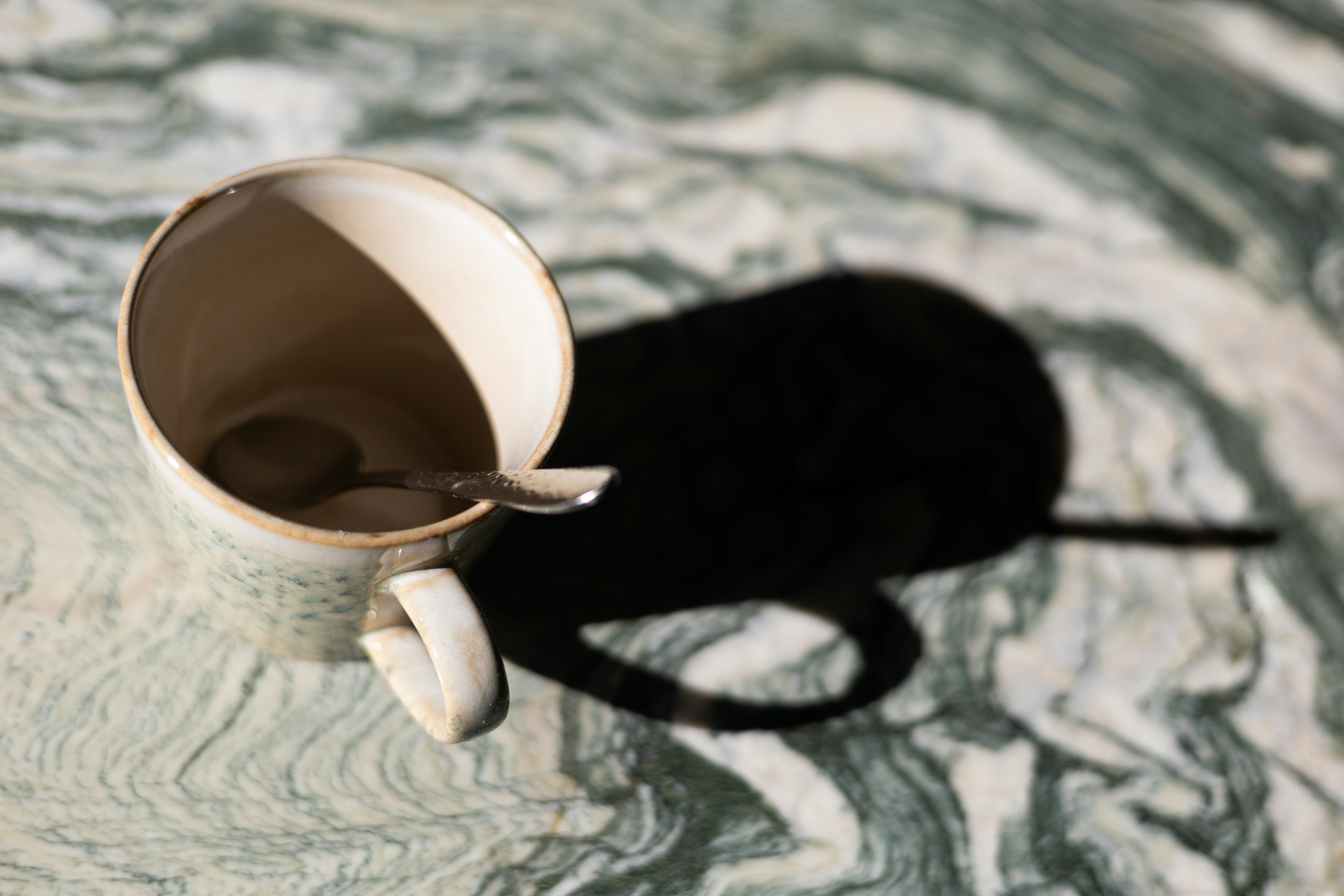Spilled Bean Shadow: A Quiet Mug Cast in Marble Light