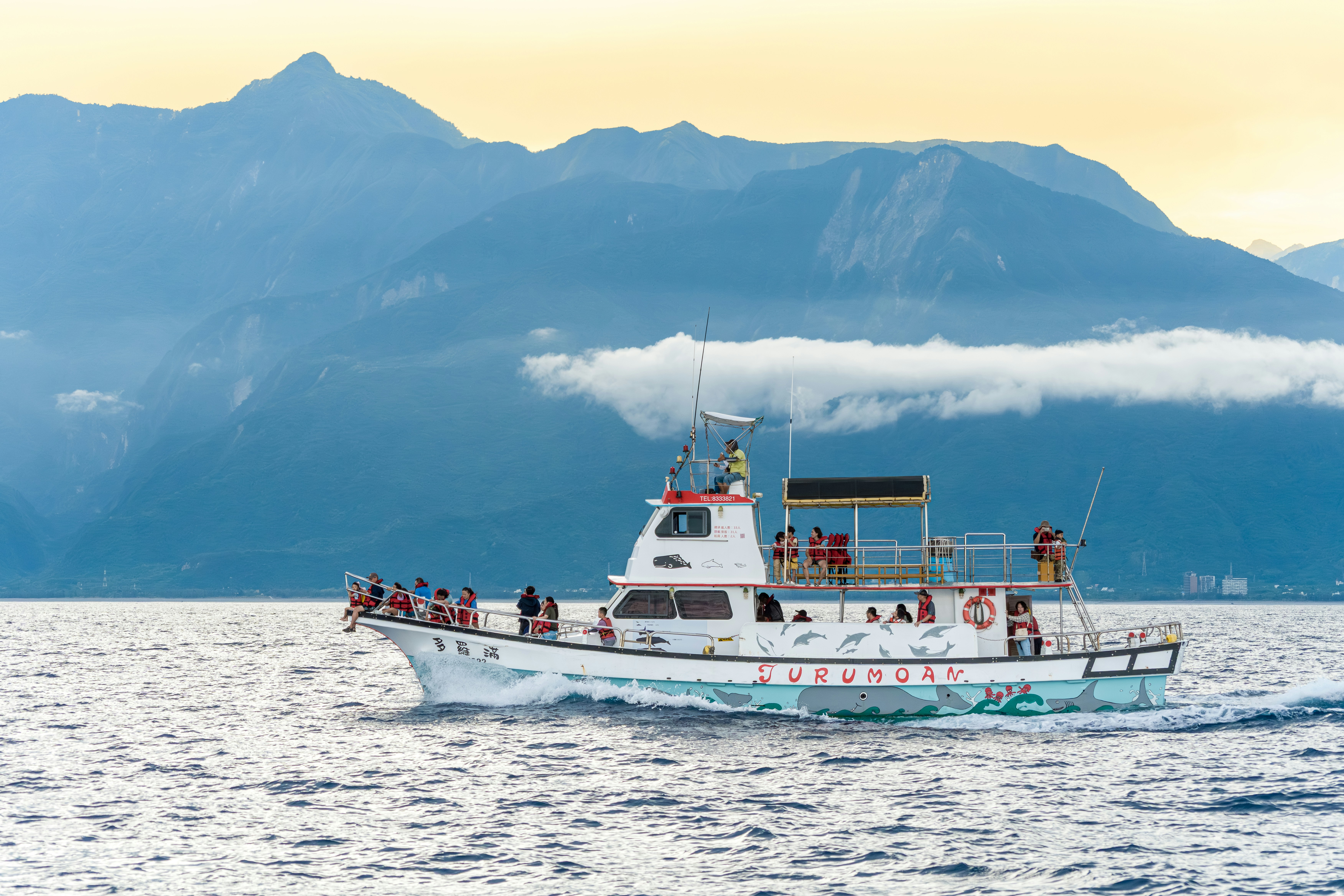 Twin-Tiered Vessel Across a Glassy Fjord