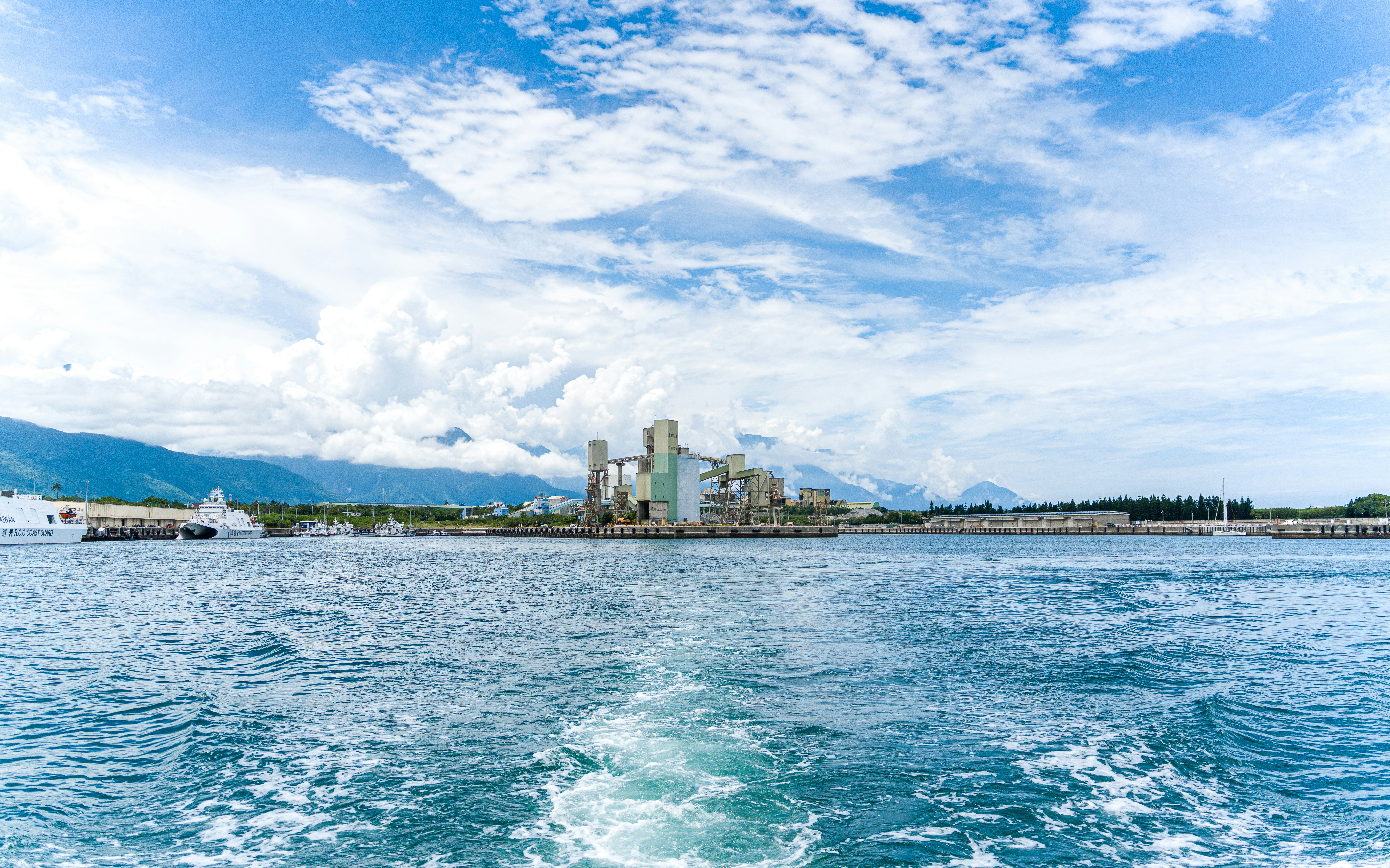 Industrial Coastline Under a Vast Sky