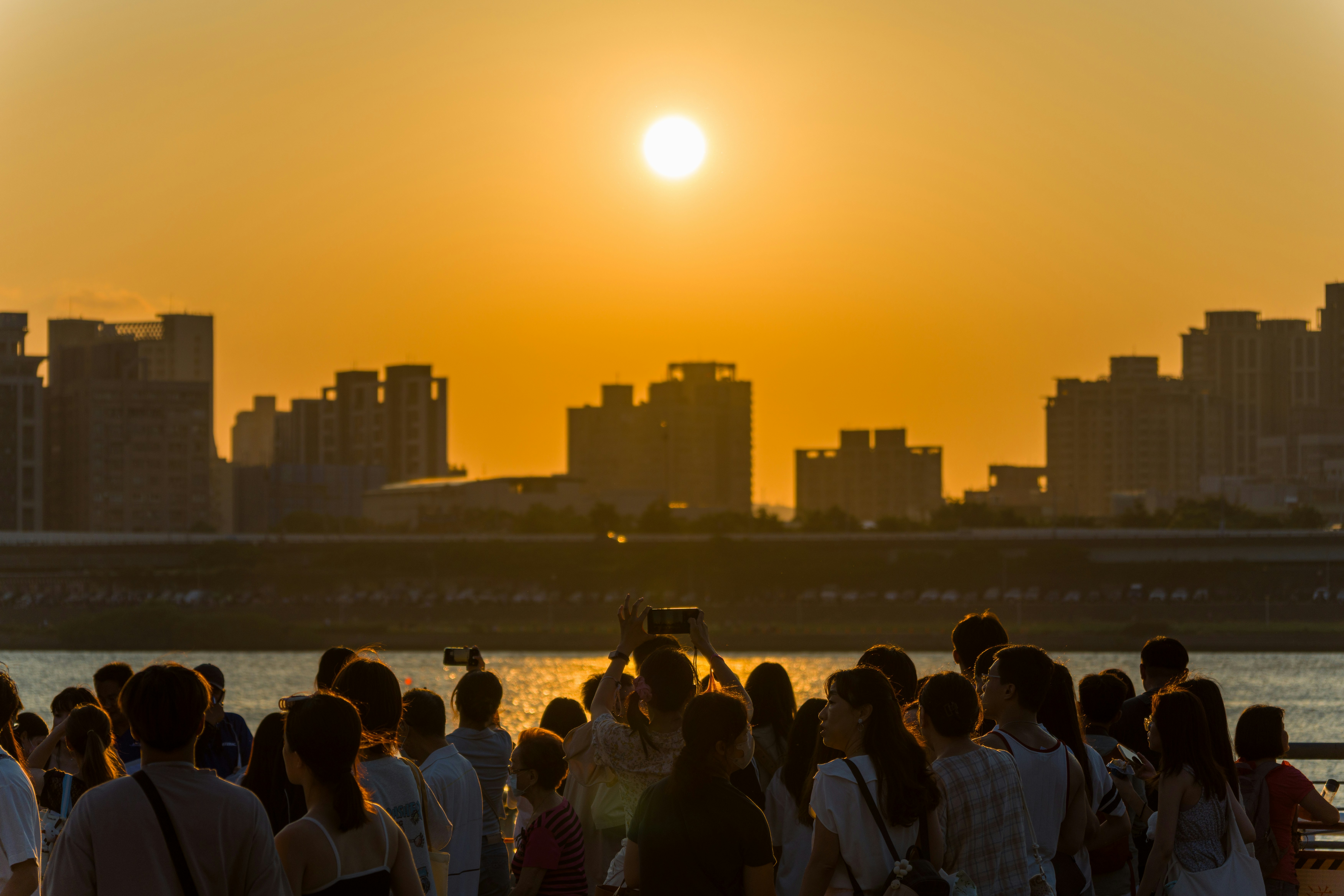 Sunset Over the Crowd: silhouettes and skyline