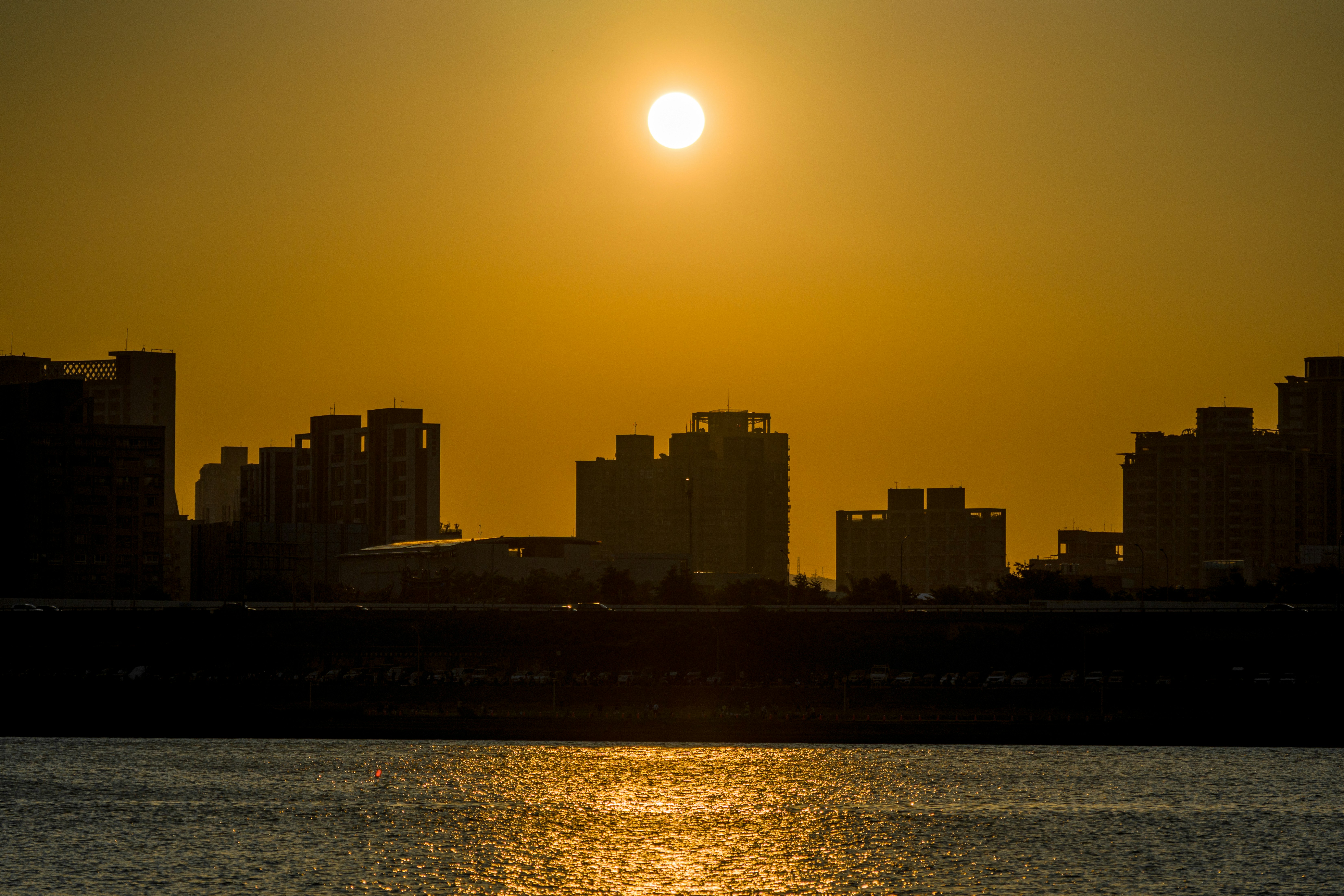 Sunset Silhouette Over a Quiet Waterfront Skyline