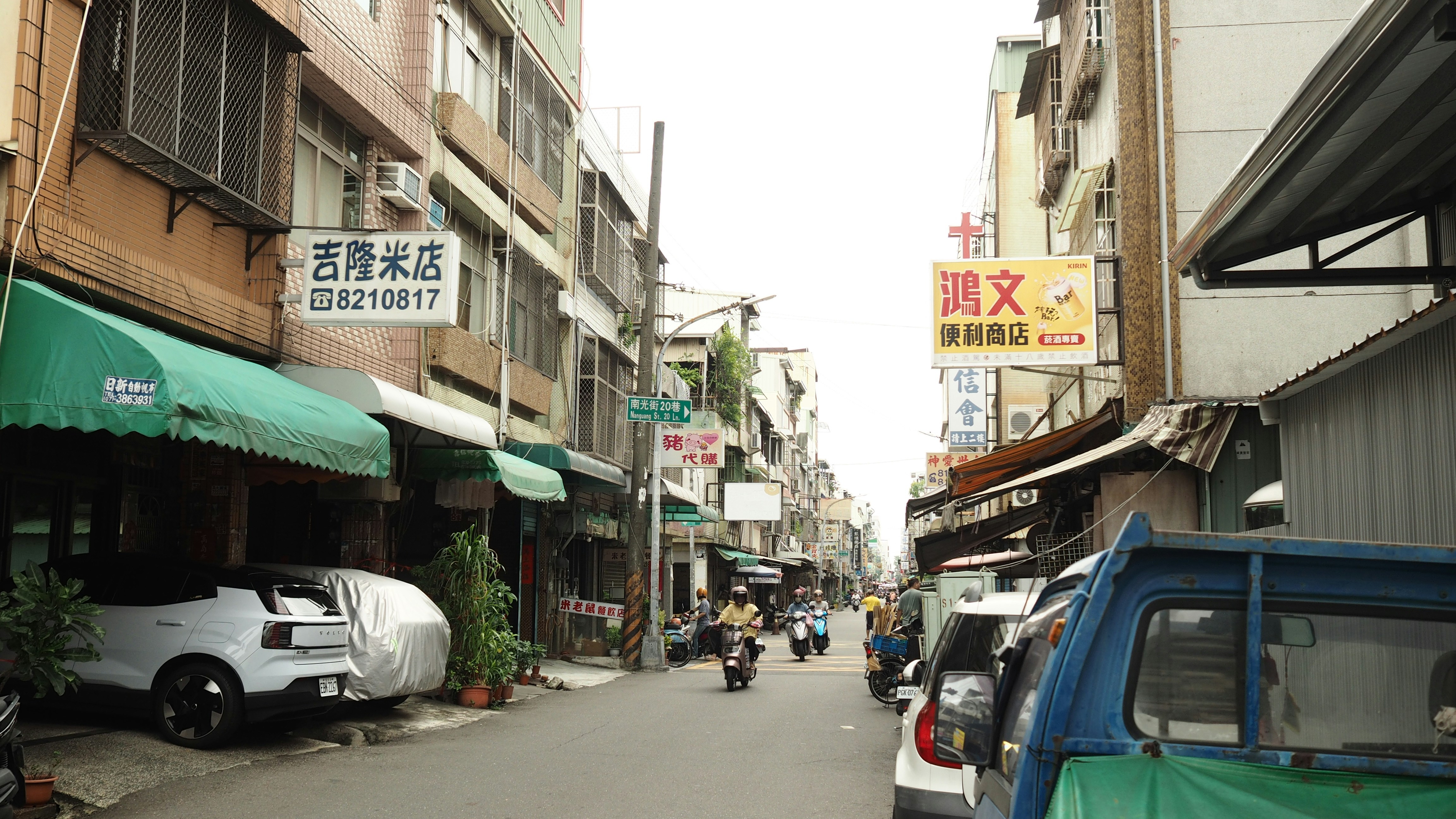 Urban Street Corridor: Signs, Motorbikes, and Storefronts