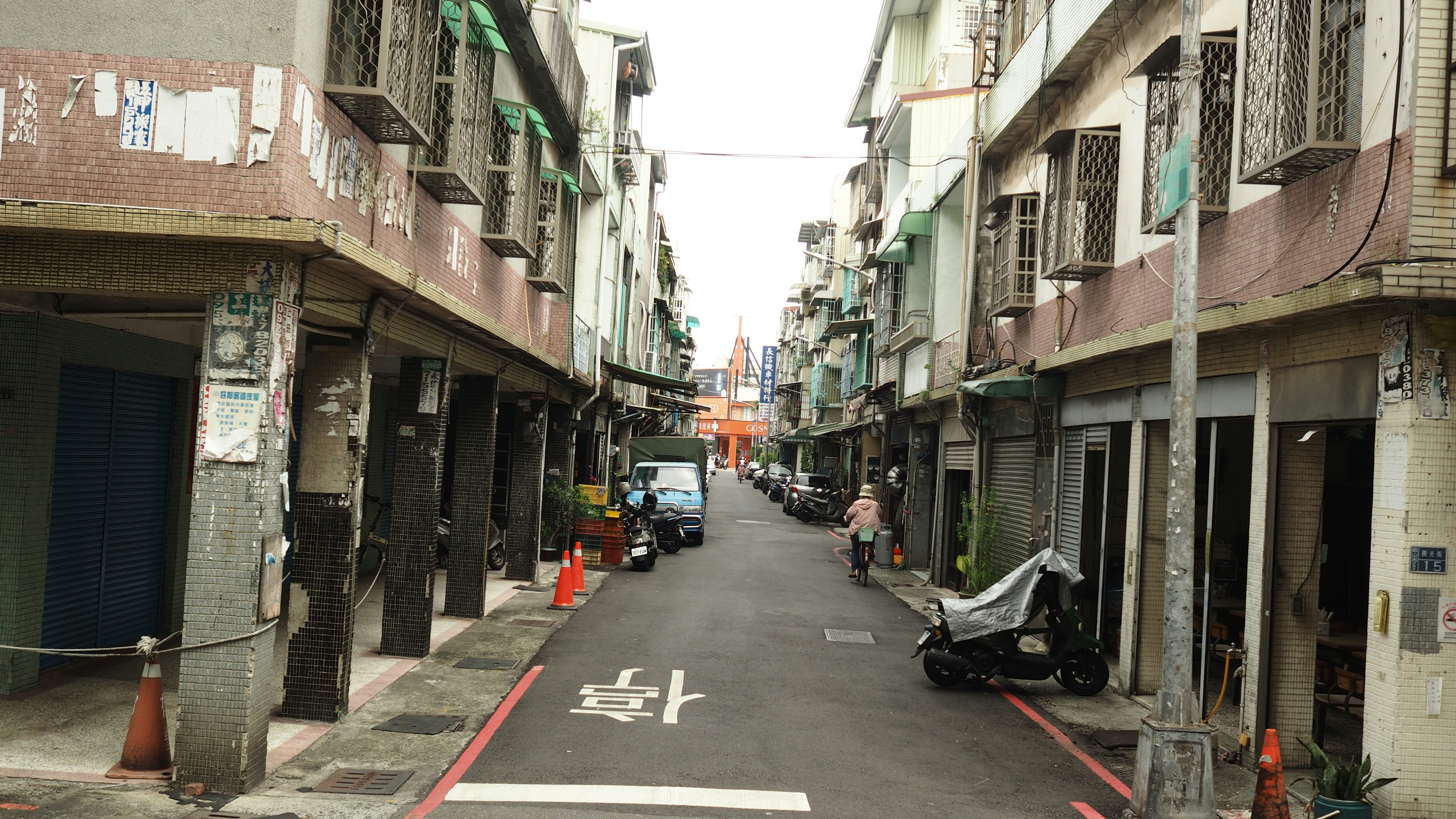 Quiet Alleyway: A Street Between Shuttered Facades
