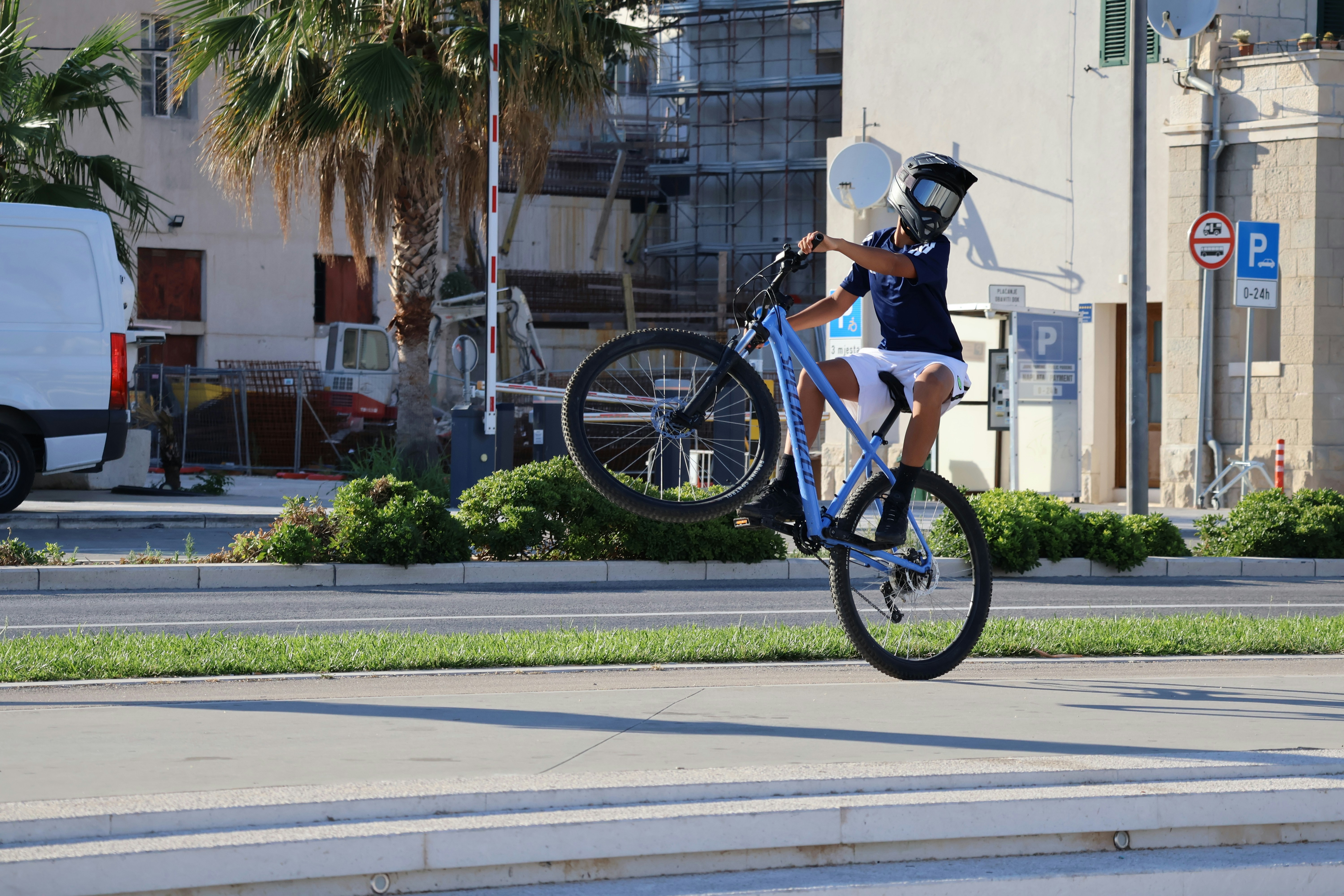 Courier of Momentum: A Wheelie in an Urban Parade