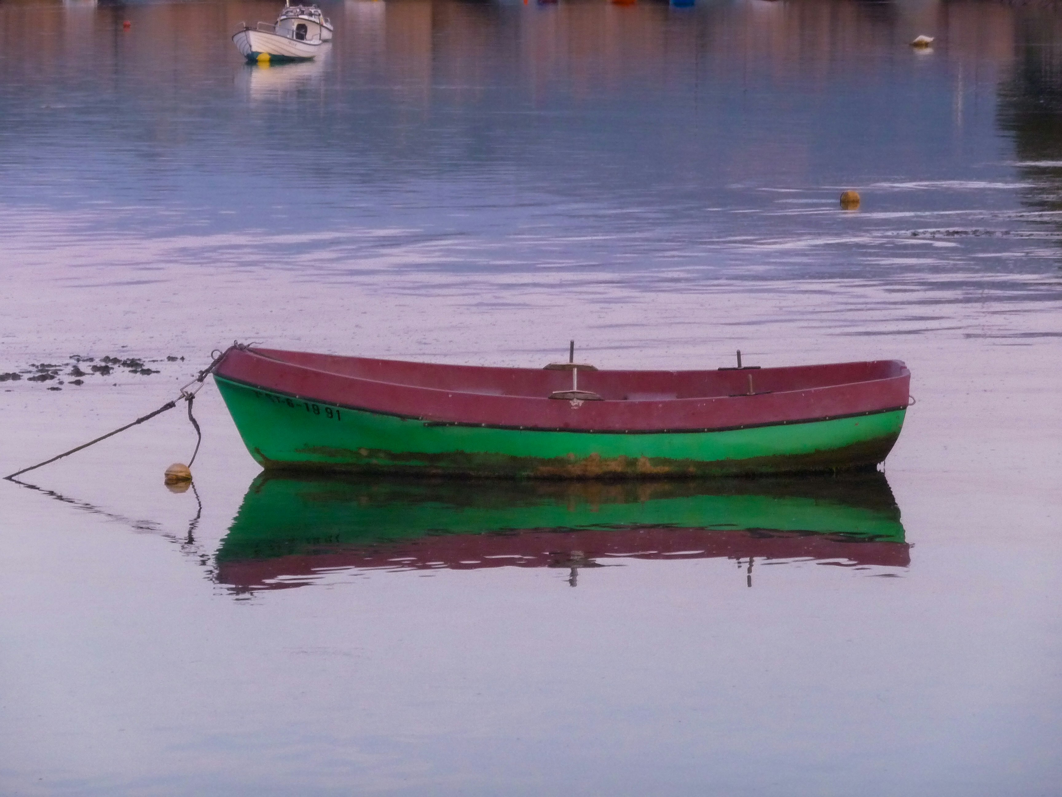 Green‑hulled Boat Adrift on a Velvet Mirror