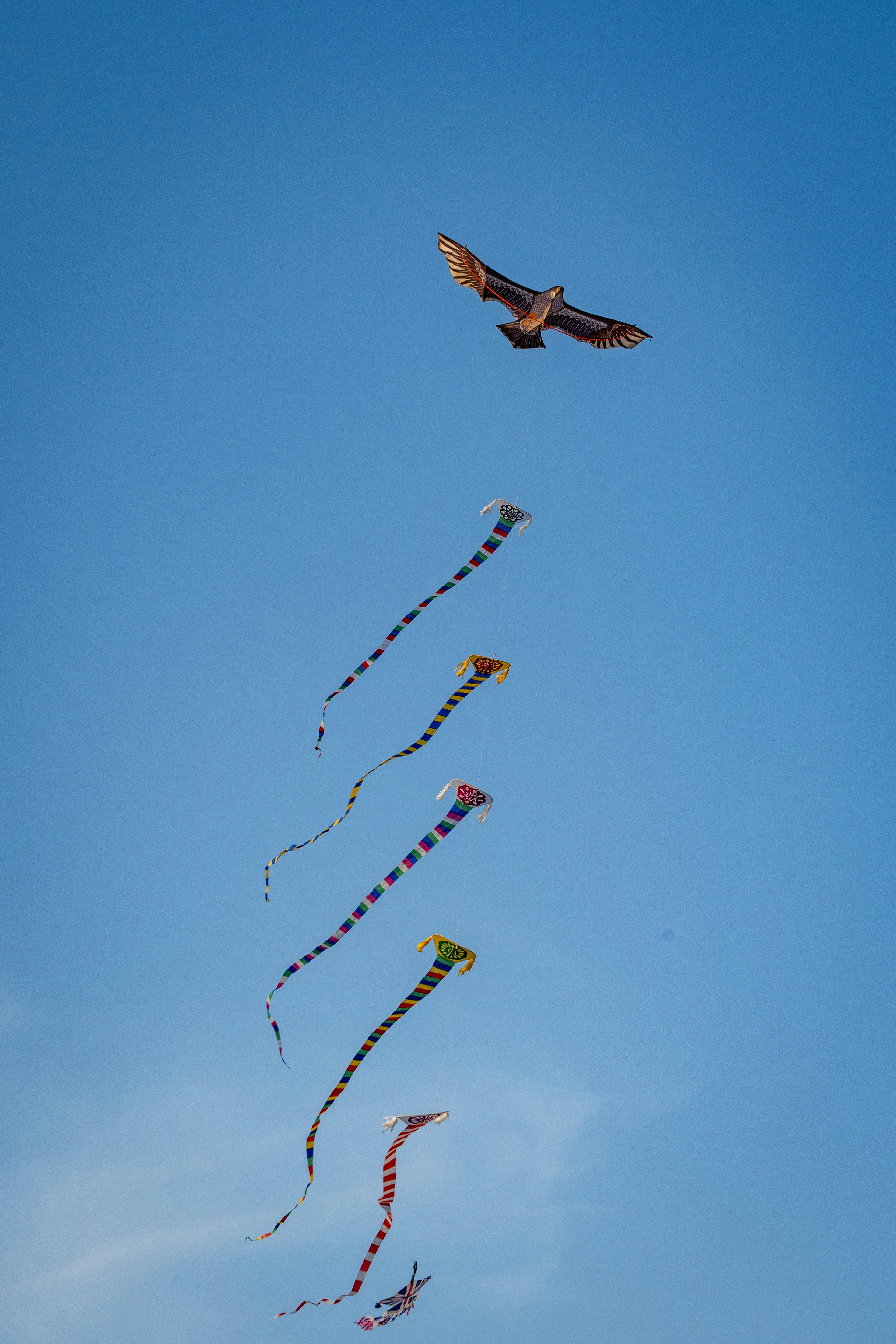 Aerial Ribbon Dance: A Kite Tugs a Painted Banner Across Open Sky