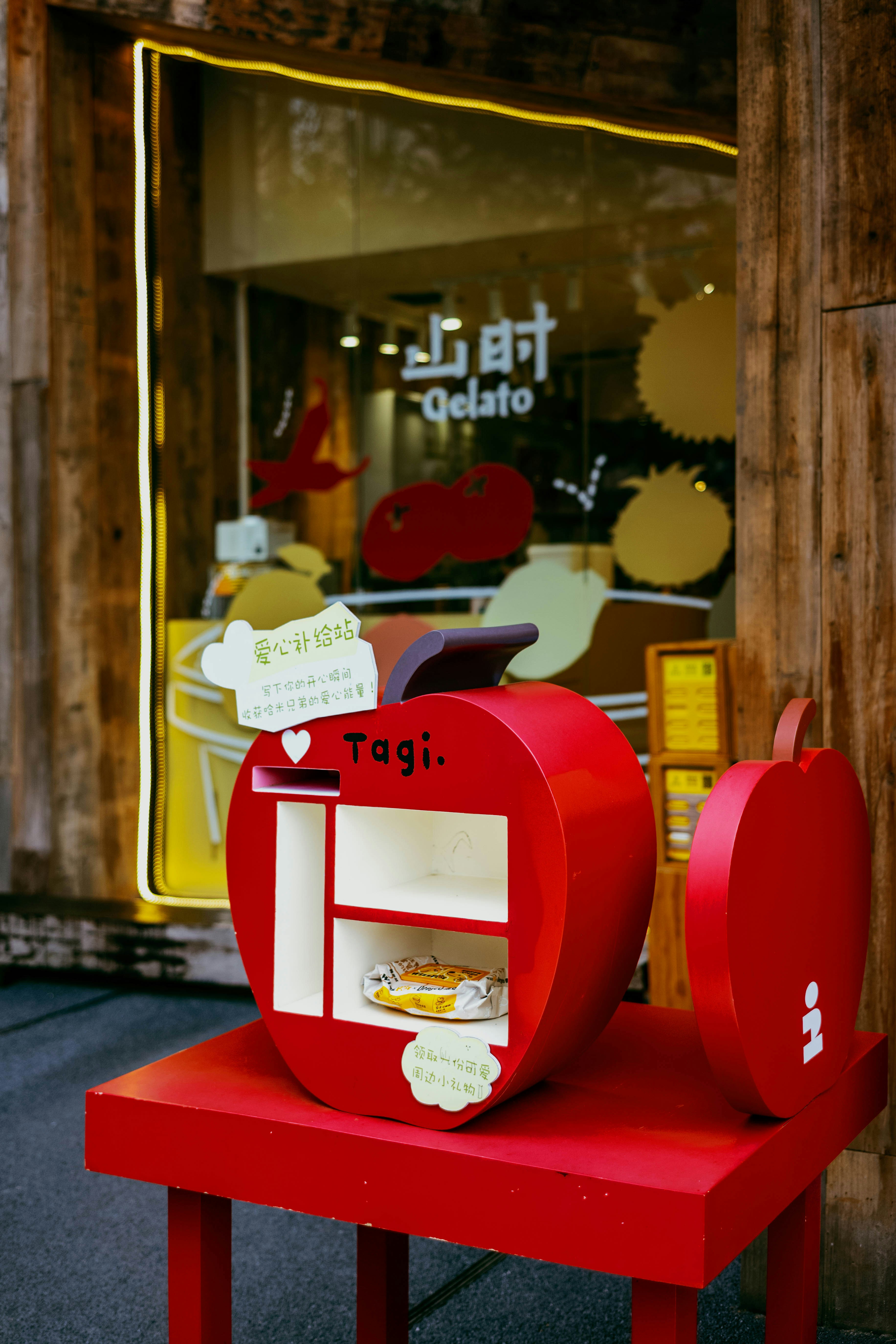 Red Apple-shaped Standee Café: A Quiet Street Scene