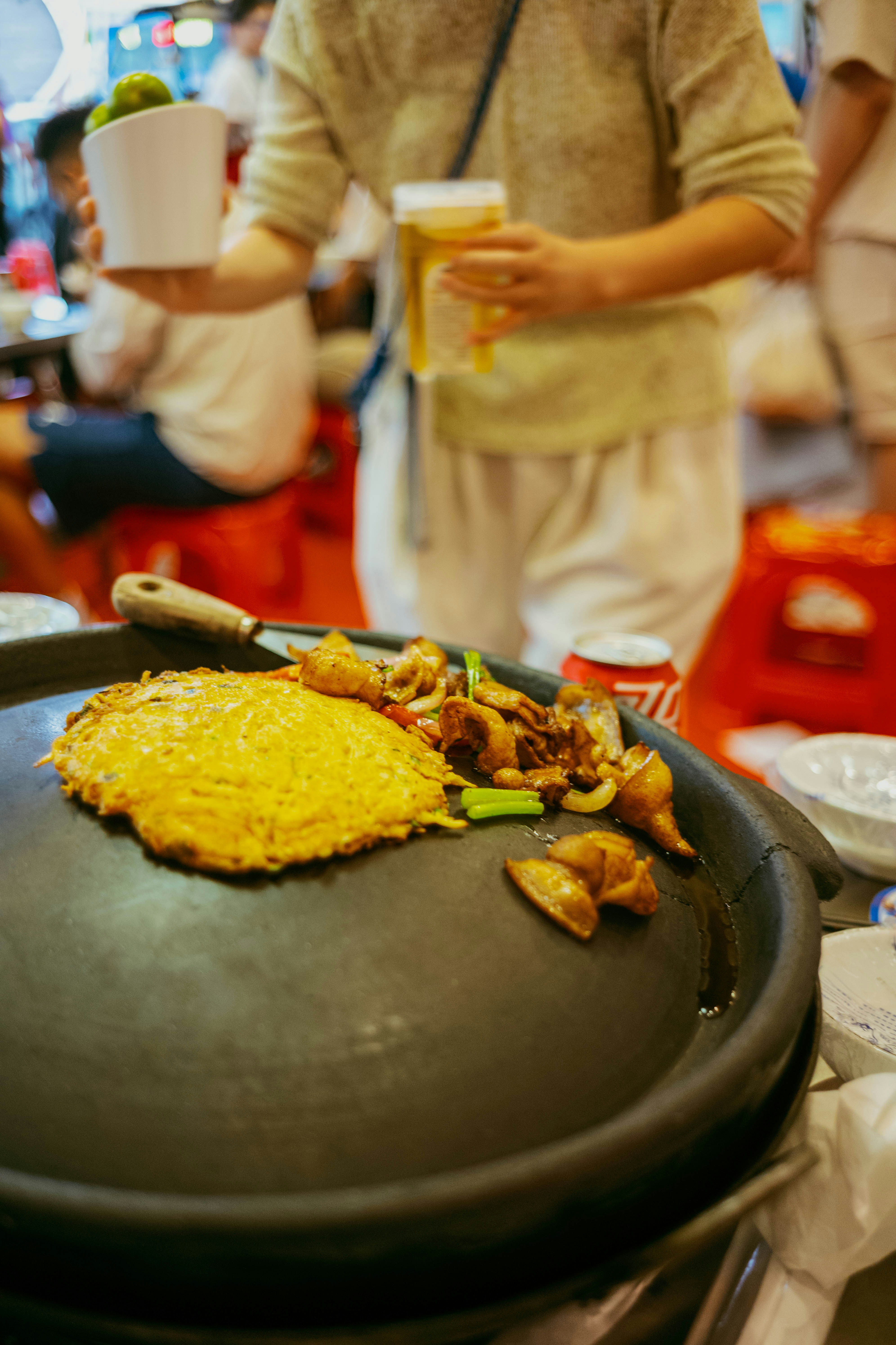 Sizzling Street Grill: A Crispy Pancake and Sautéed Delights in a Bustling Market