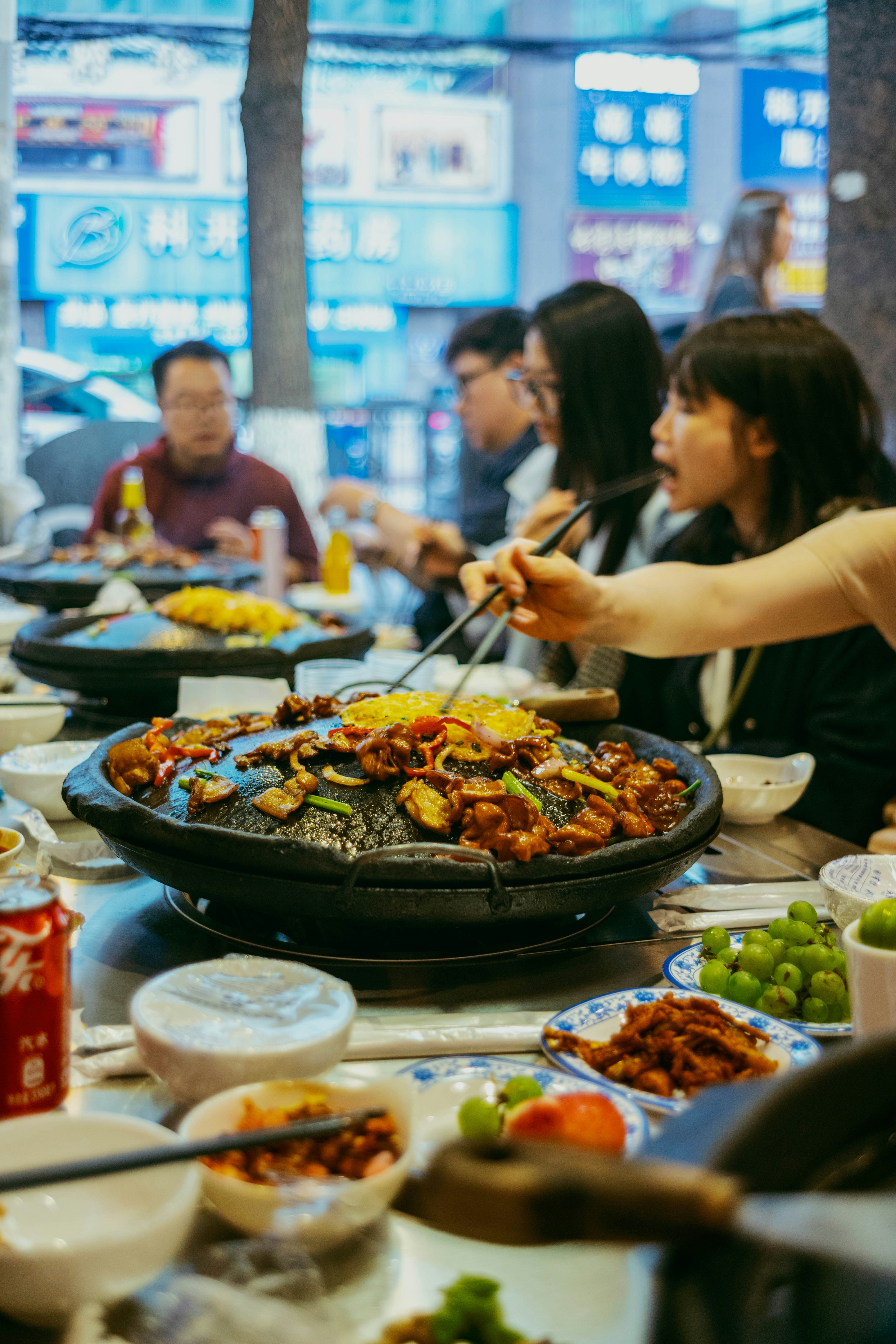 Sizzling communal pot at a bustling street-side meal