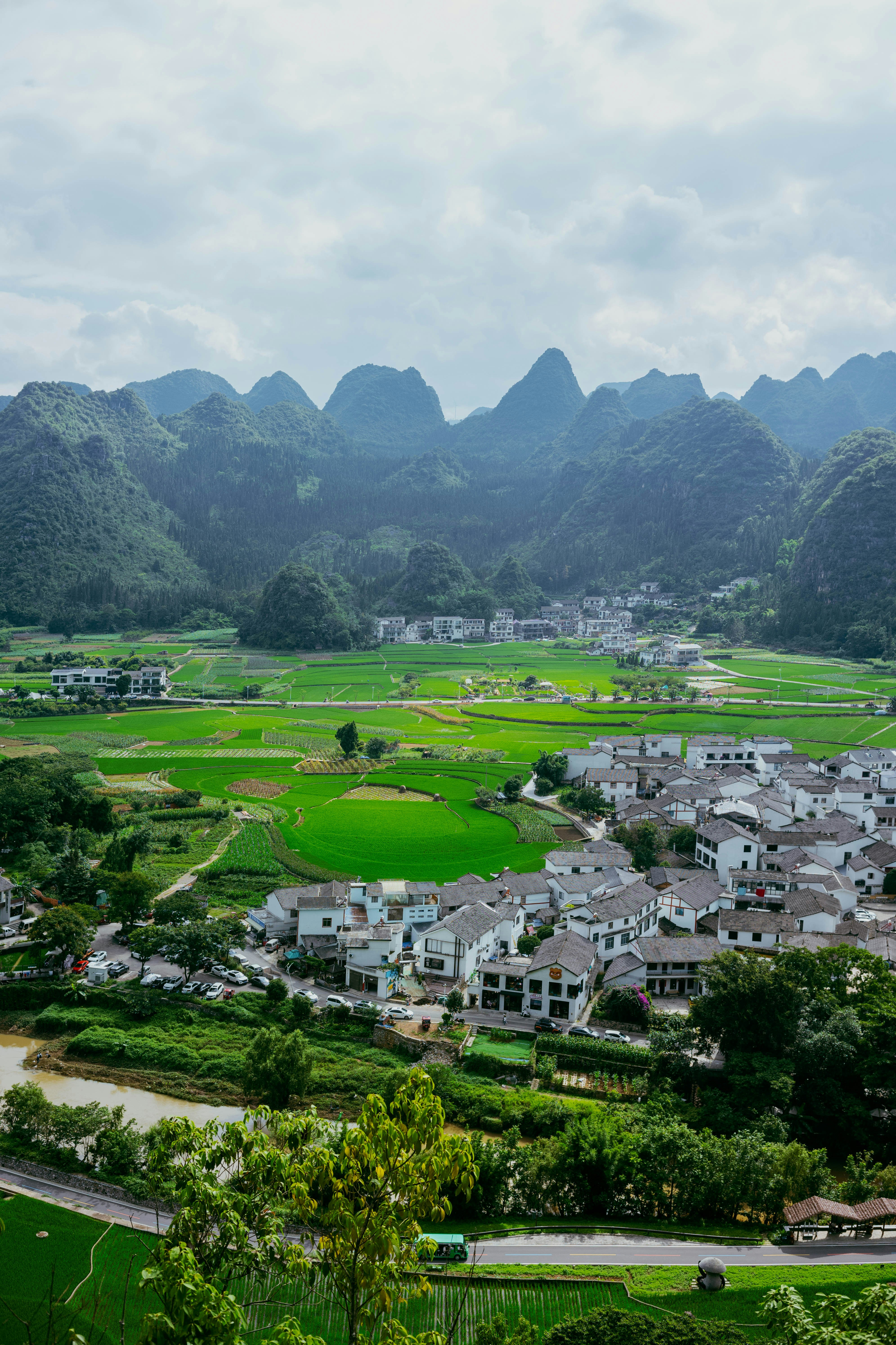 Green Mosaic: Terraced Fields and Village Amid Carved Karst