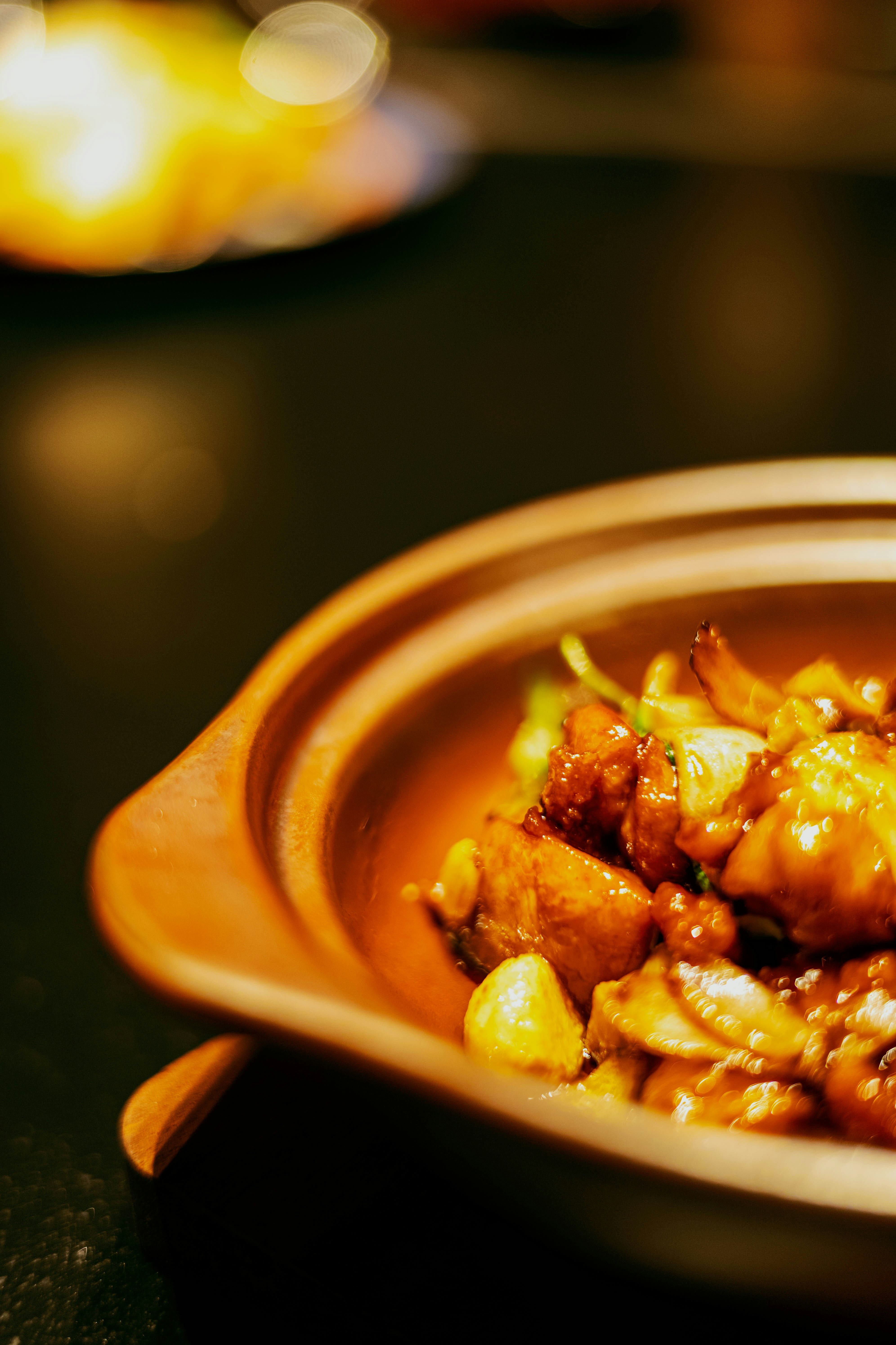 Warm Clay Pot Comfort: Charred Chicken and Potatoes in a Rustic Dish