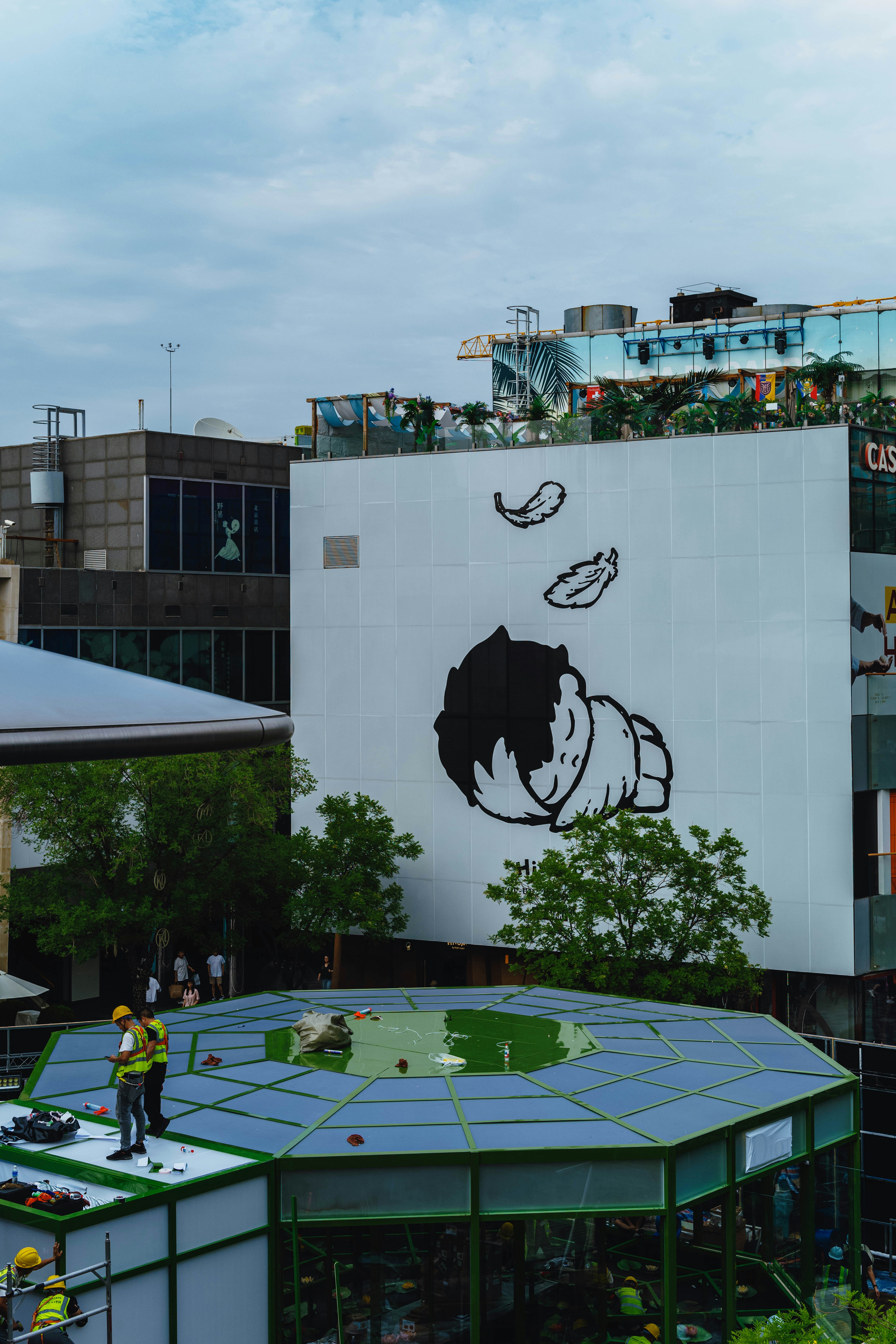 Mural Headwinds Over a Green Atrium