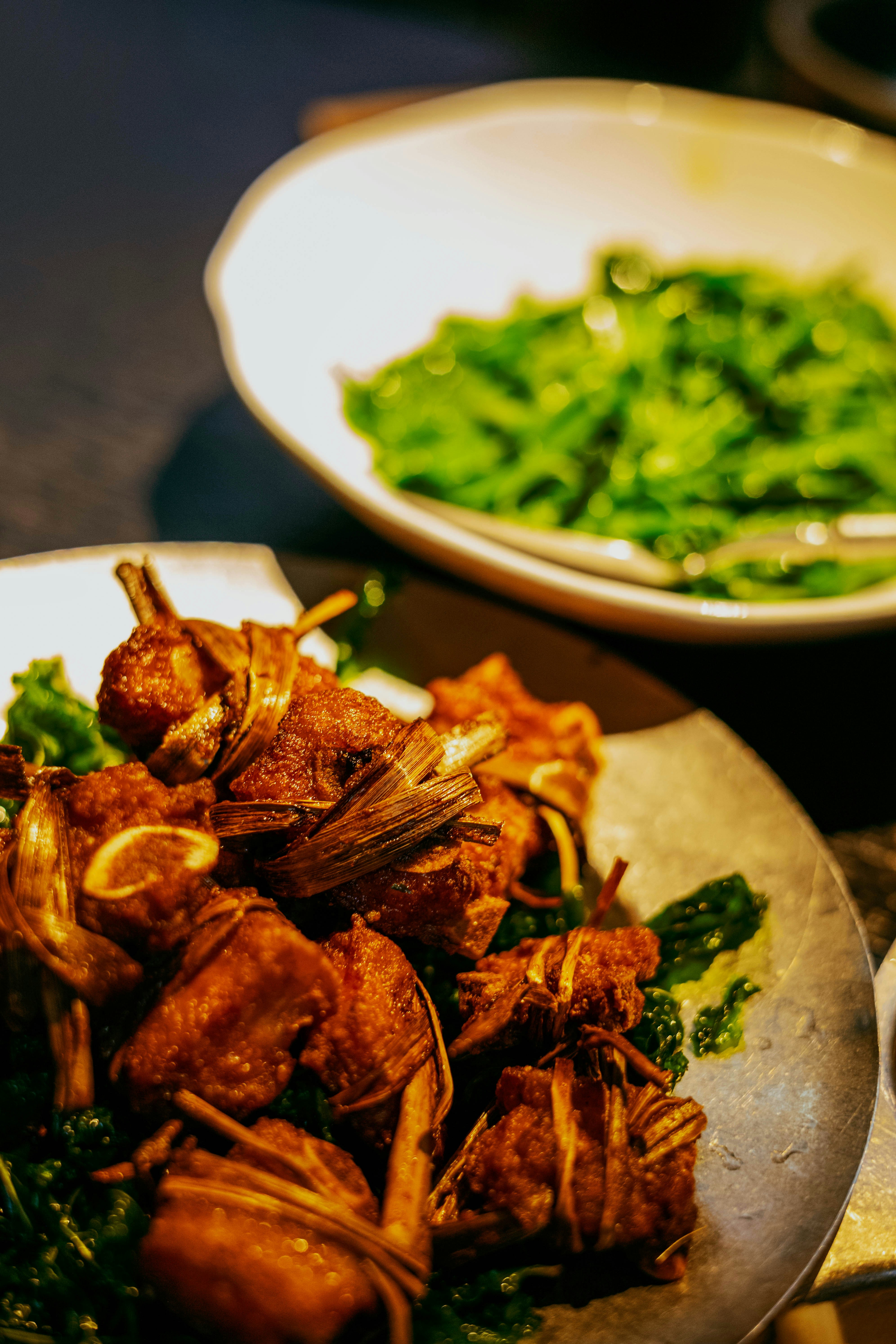 Crispy-Lacquered Lamb Skewers on a Greens-Embellished Plate