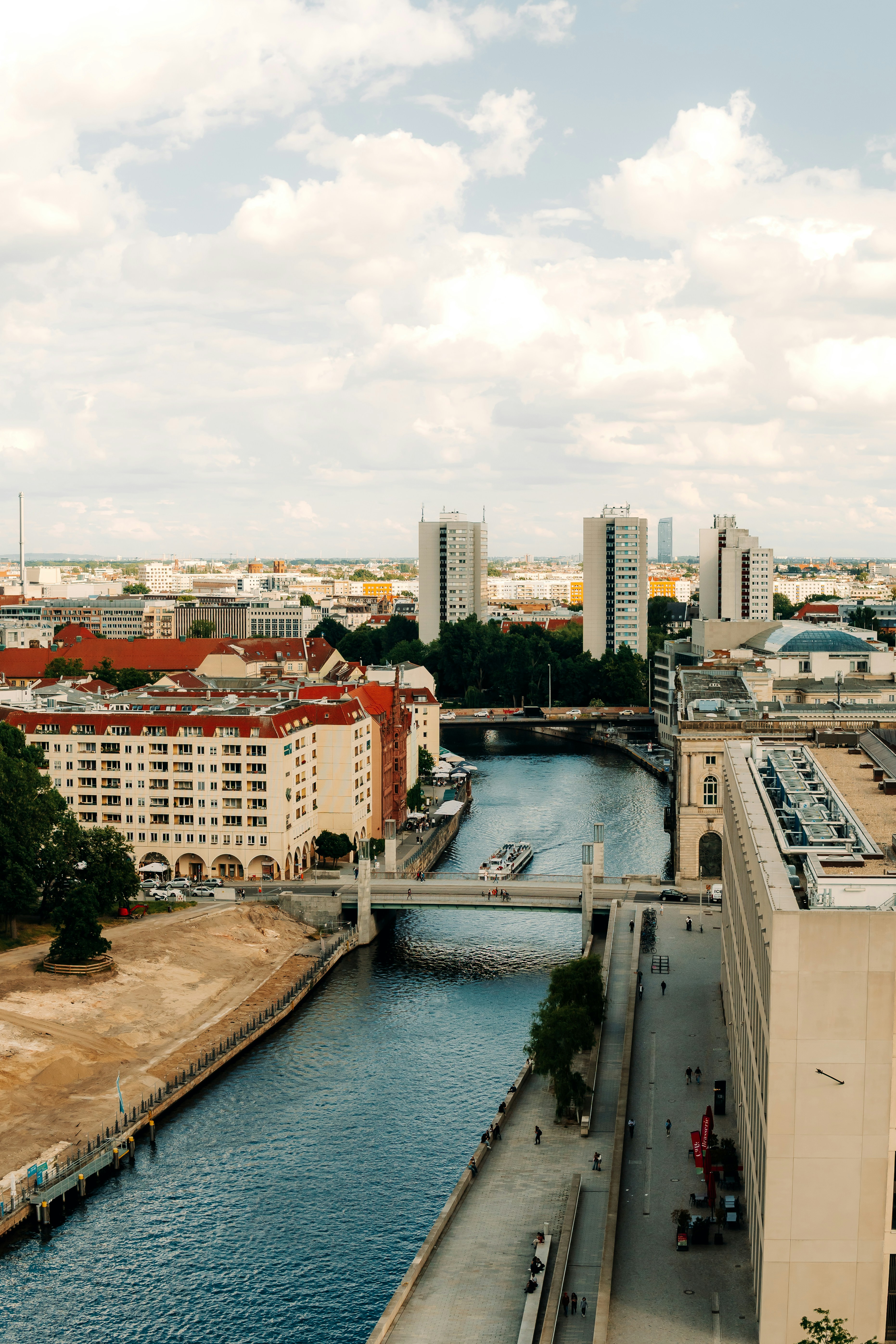 City Channel: Bridges, Waterways, and Red Rooflines Framing a Modern Skyline