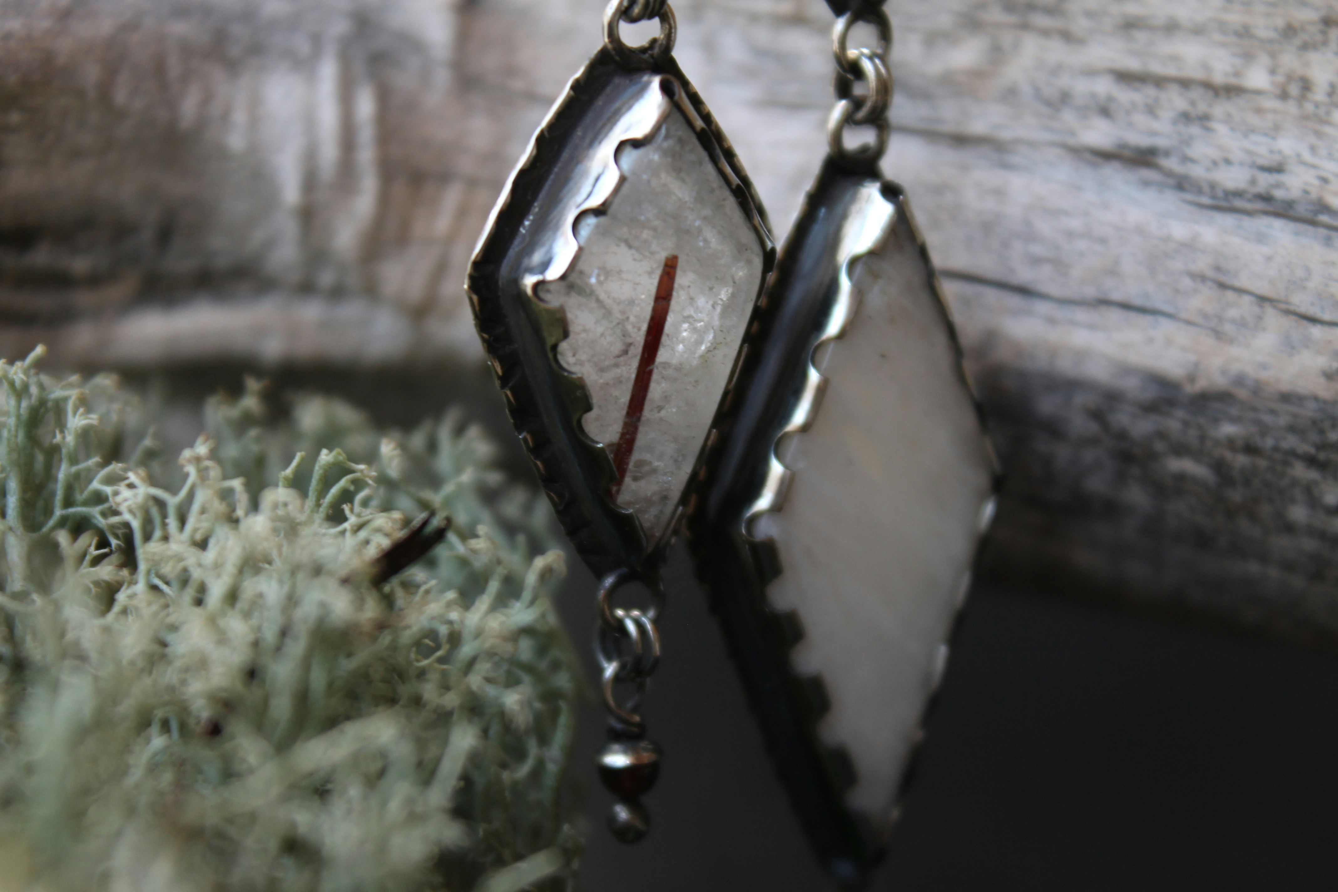Glassy pendant reflections against weathered wood